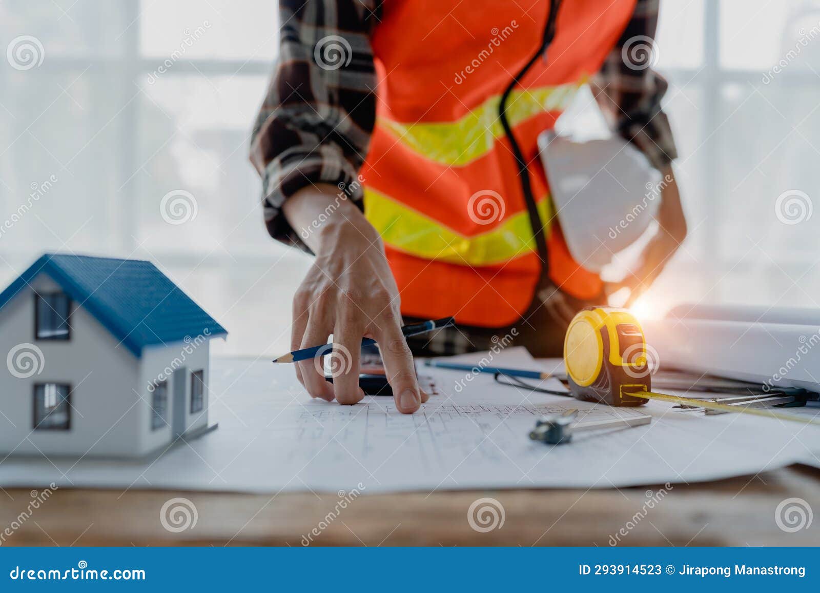 Engineer Brainstorming and Measuring for Cost Estimating on Blueprint ...