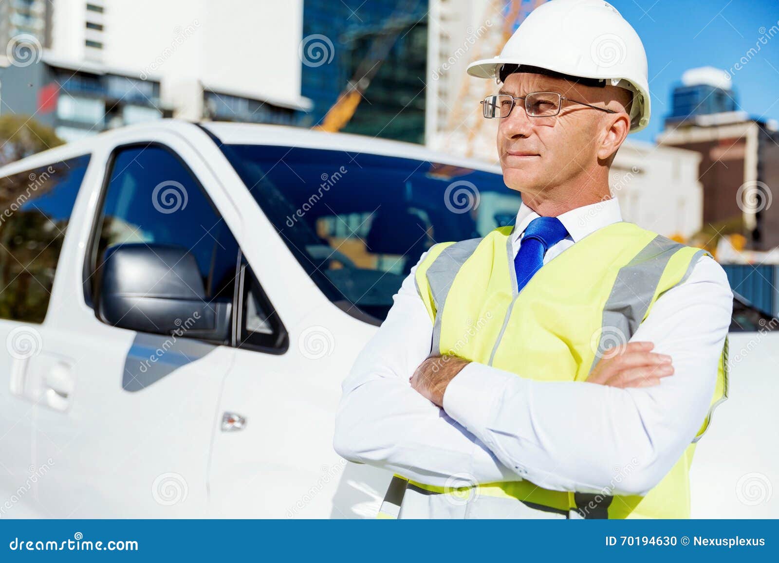 Engineer Builder Wearing Safety Vest With Blueprint At Construction ...