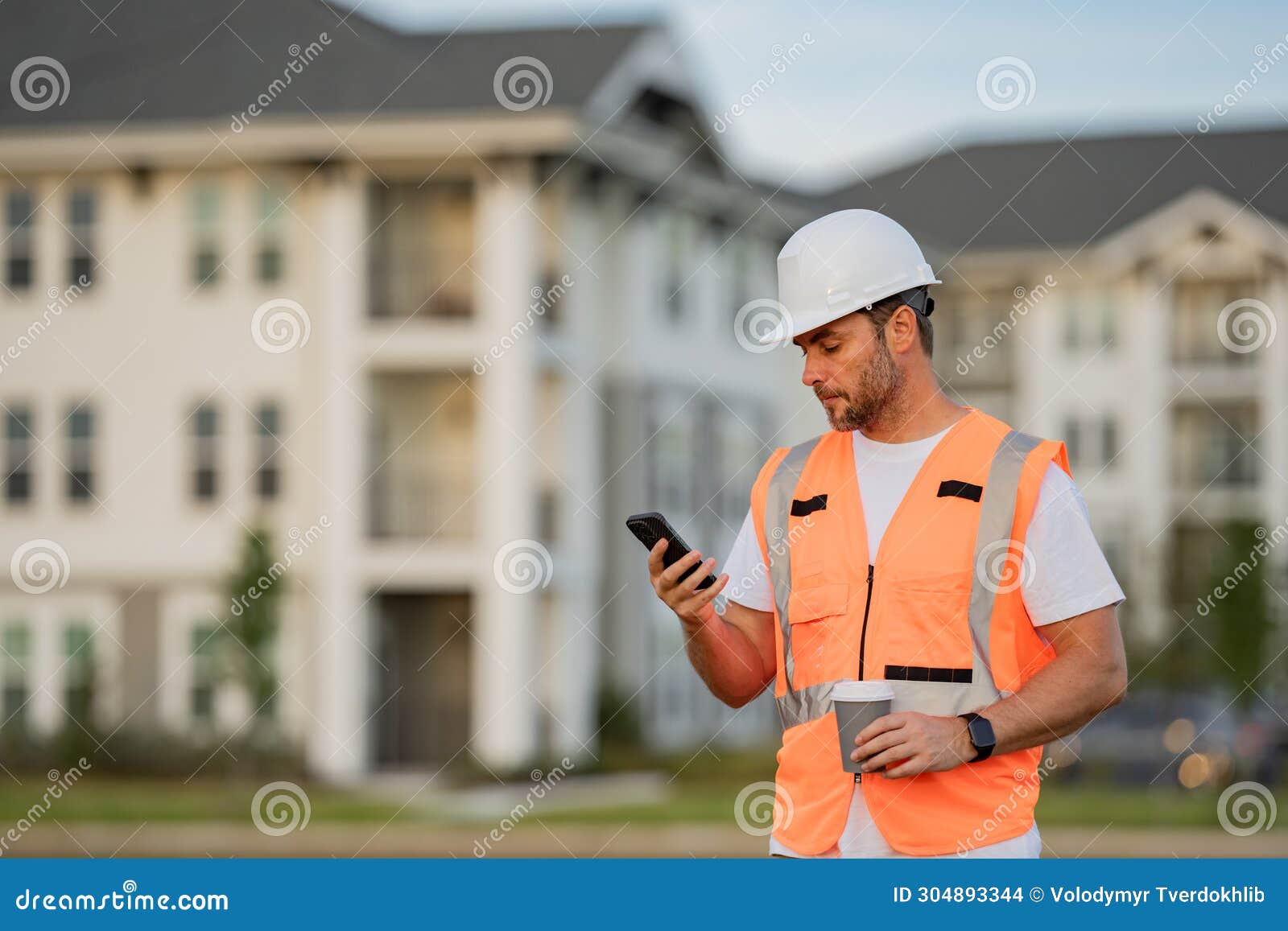Engineer Builder Drinking Take Away Coffee Using Phone on Break ...