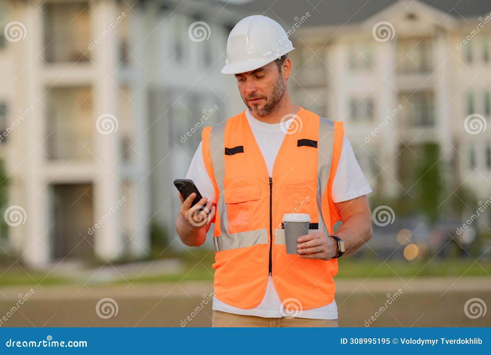 Engineer Builder Drinking Take Away Coffee Using Phone on Break ...