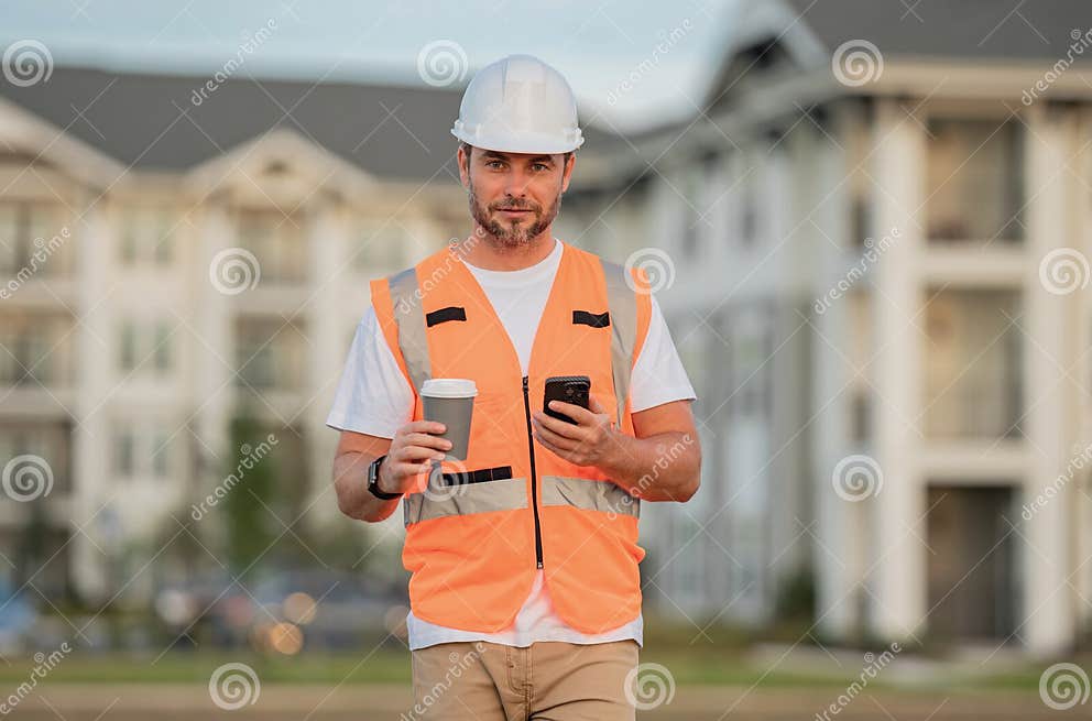 Engineer Builder Drinking Take Away Coffee Using Phone on Break ...