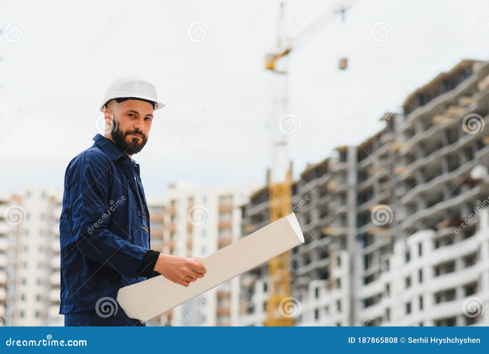 Engineer Builder Wearing Safety Vest with Blueprint at Construction ...