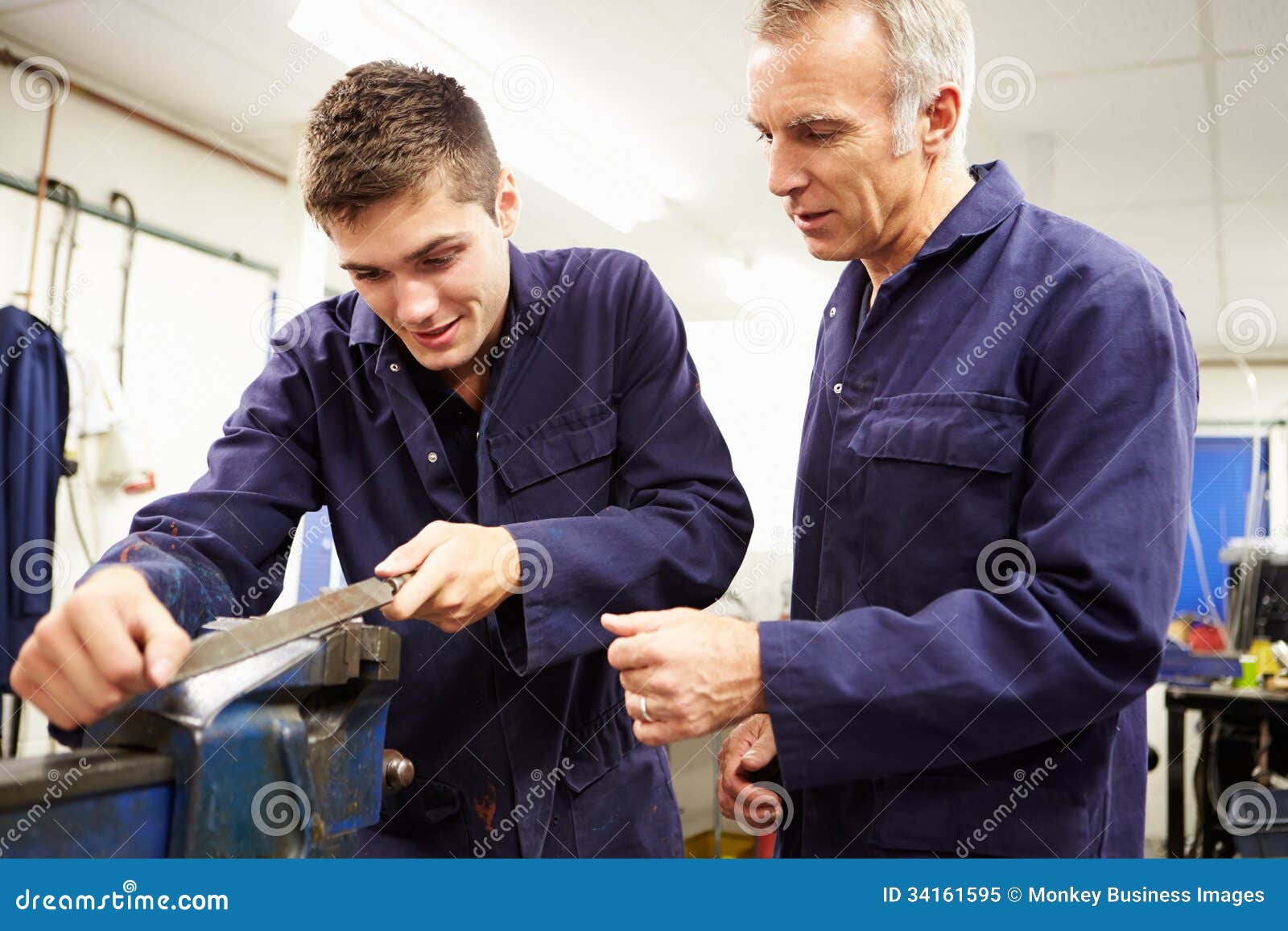 Engineer Checking Trainee S Work on Factory Floor Stock Image - Image ...