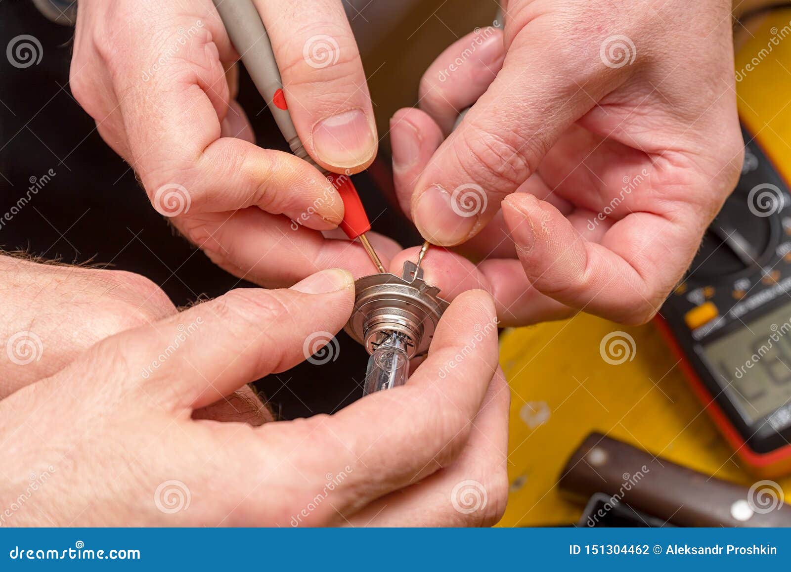 Engineer Checks a Light Bulb for Efficiency with the Help of Multimeter ...