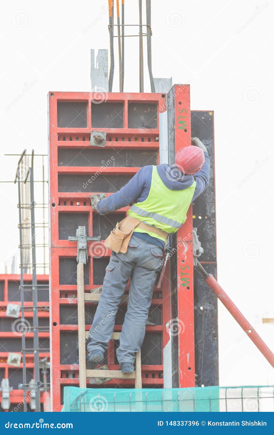 An Engineer is Climbing Up the Stairs at the Constraction Site ...