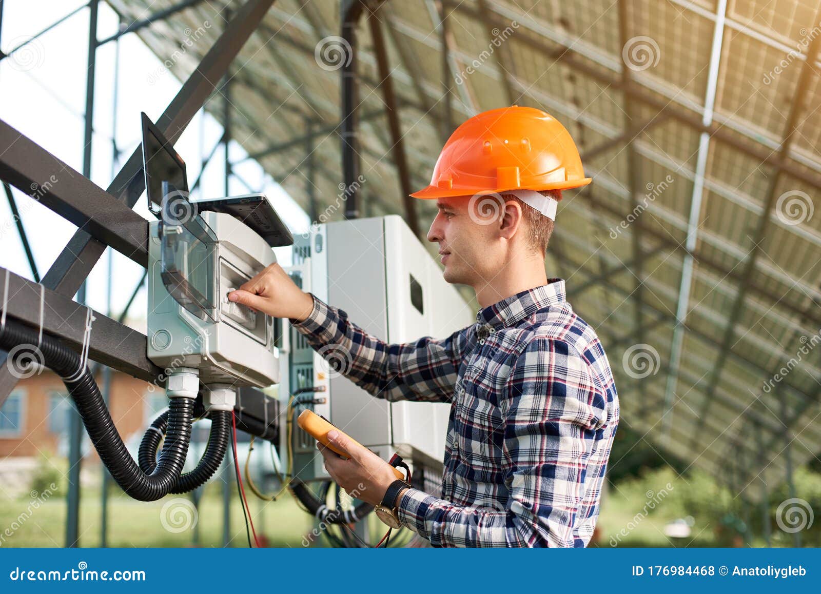 Engineer Conducts Latest Work on Solar Cell Launch. Guy in Helmet with ...