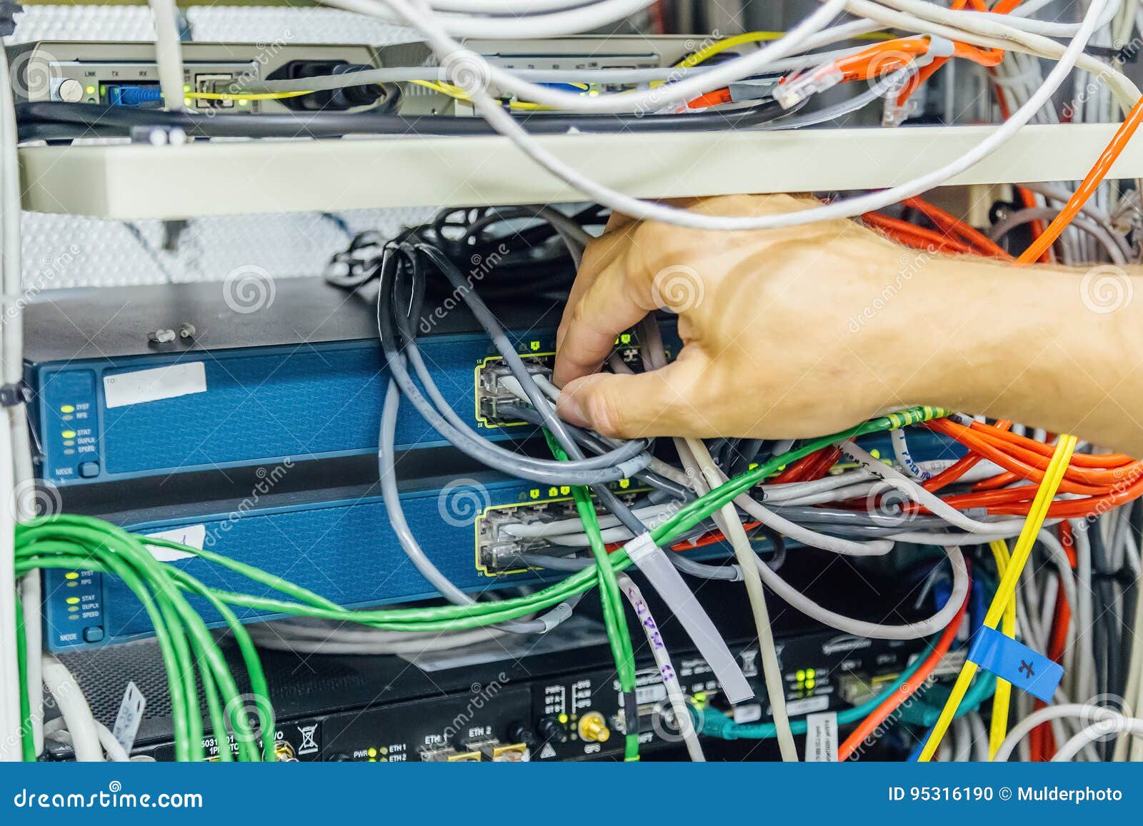 Engineer Connecting Network Cable To Switch of Fiber Optic Hub for ...