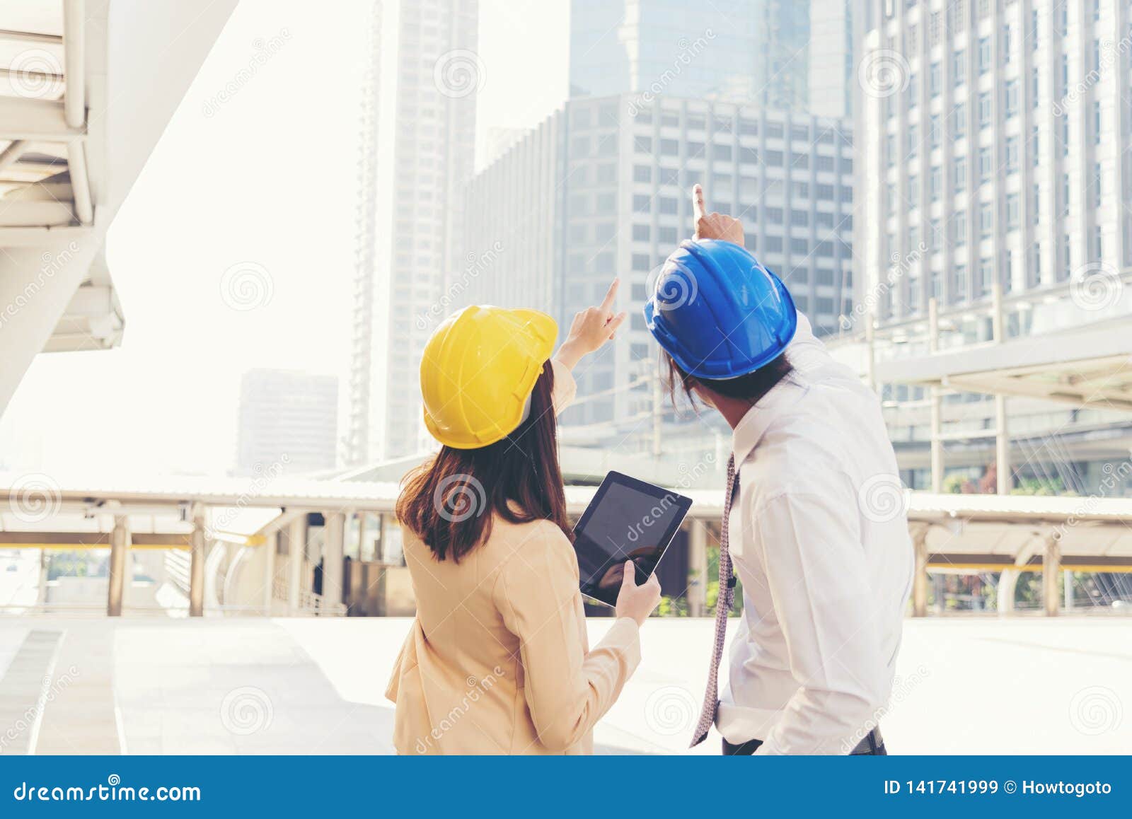 Engineer and Construction Manager Foreman Working on Building Site ...