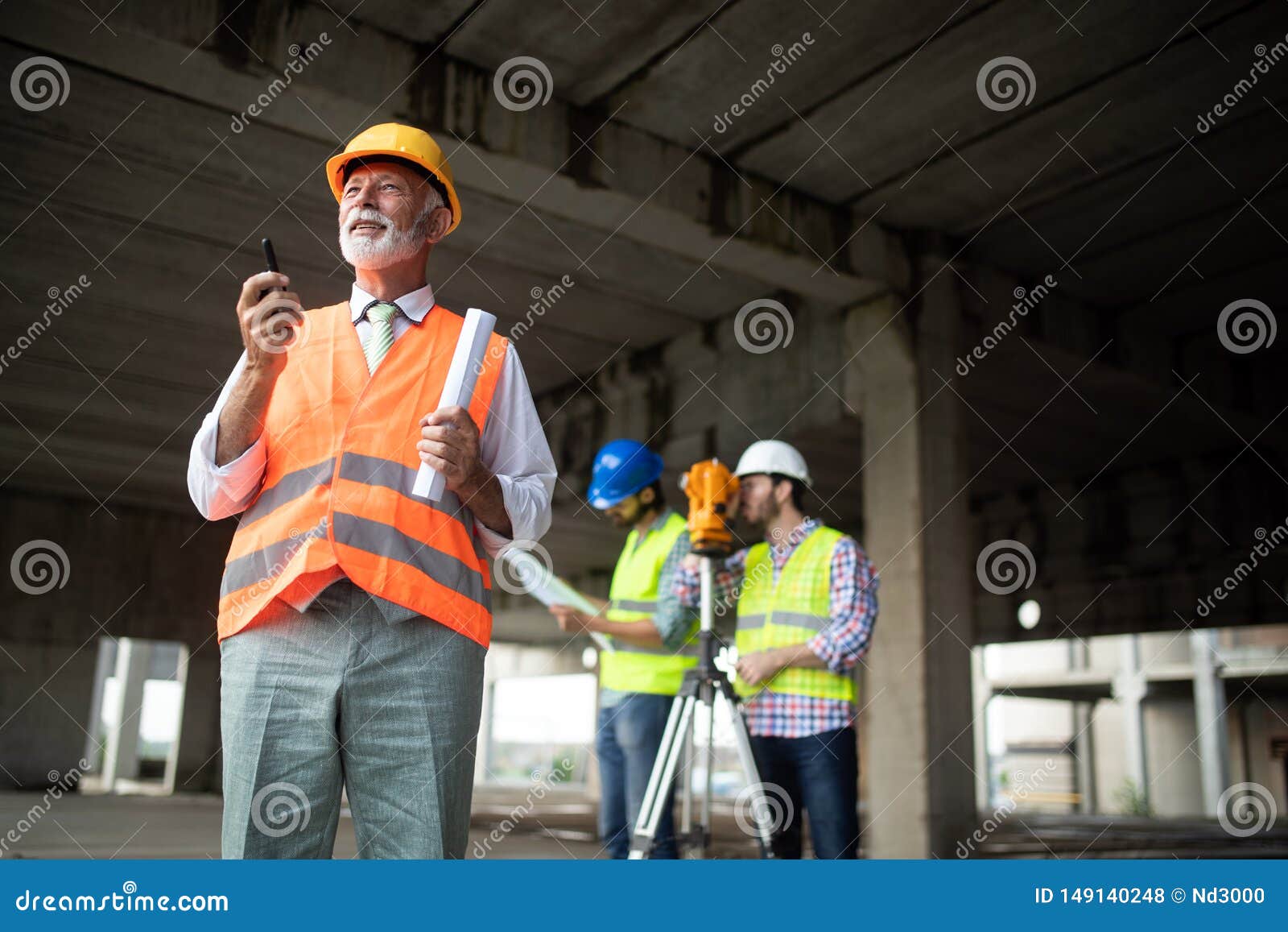 Engineer and Construction Site Manager Dealing with Blueprints and ...