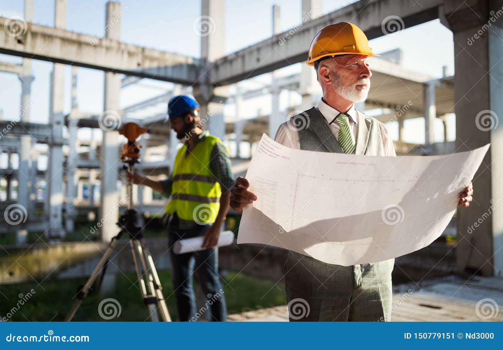 Engineer and Construction Site Manager Dealing with Blueprints and ...