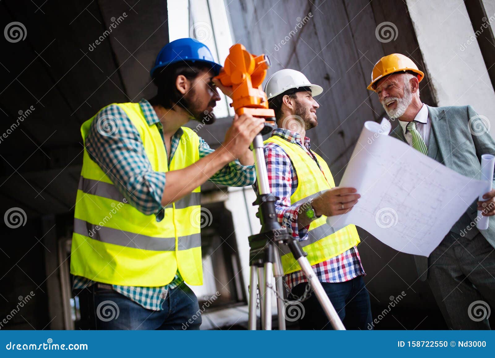 Engineer and Construction Site Manager Dealing with Blueprints and ...