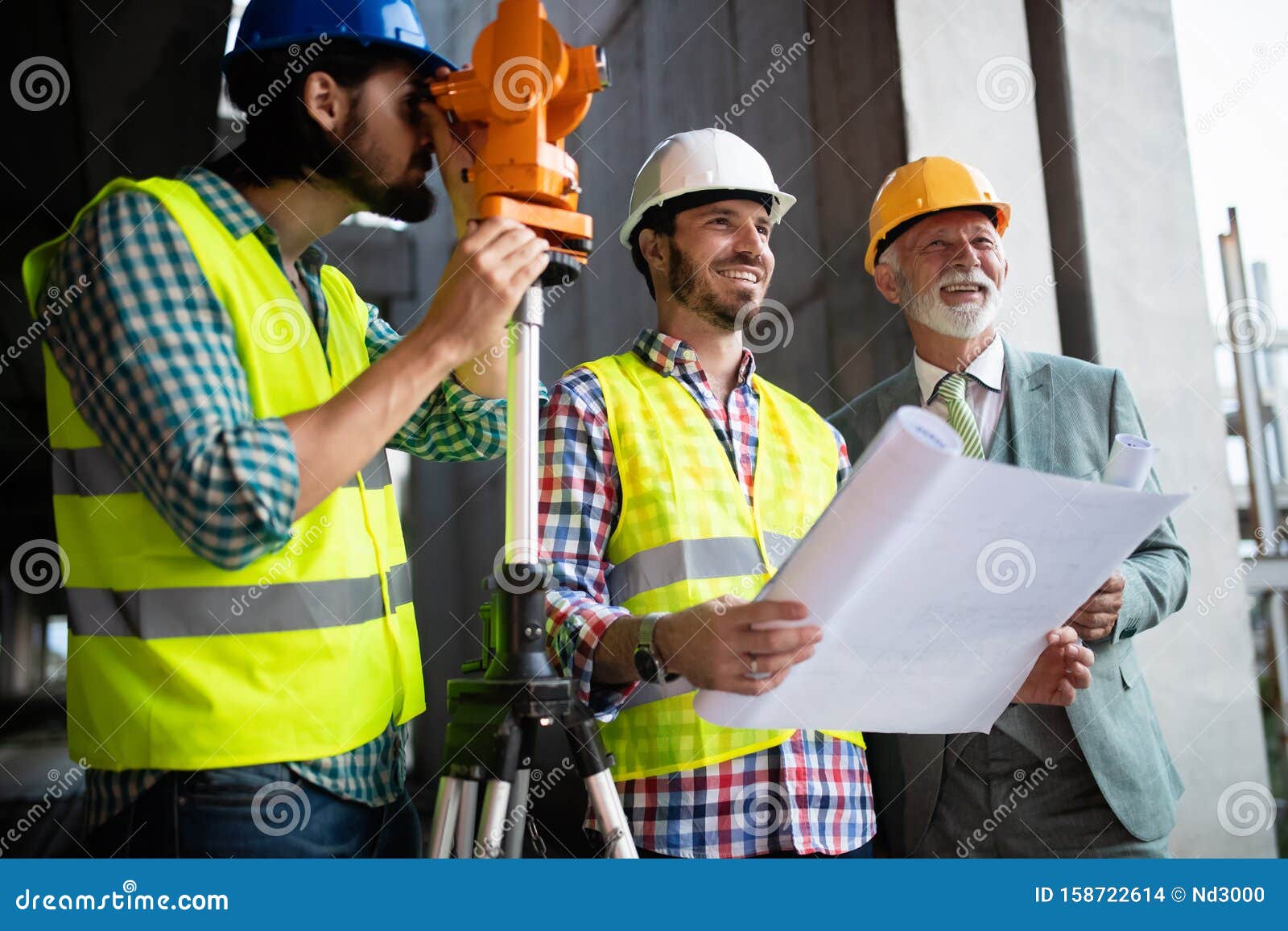 Engineer and Construction Site Manager Dealing with Blueprints and ...