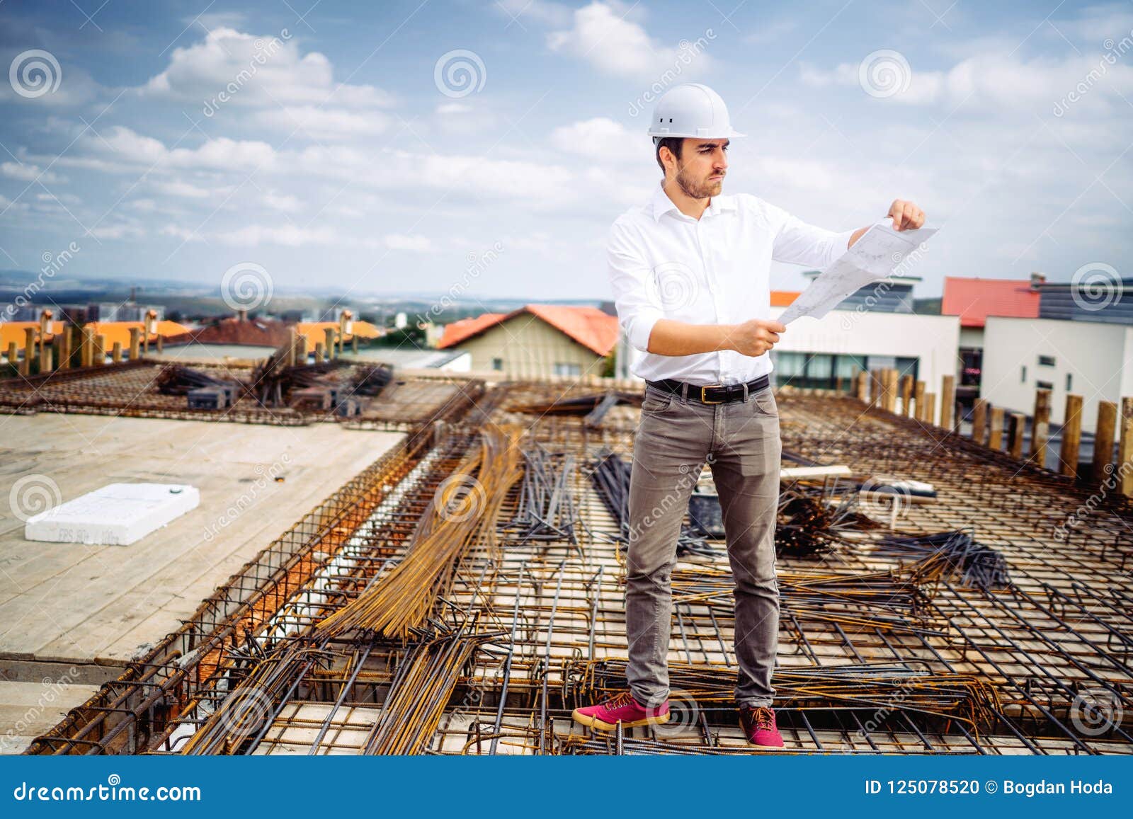 Engineer on Construction Site Working and Supervising Workers Stock ...