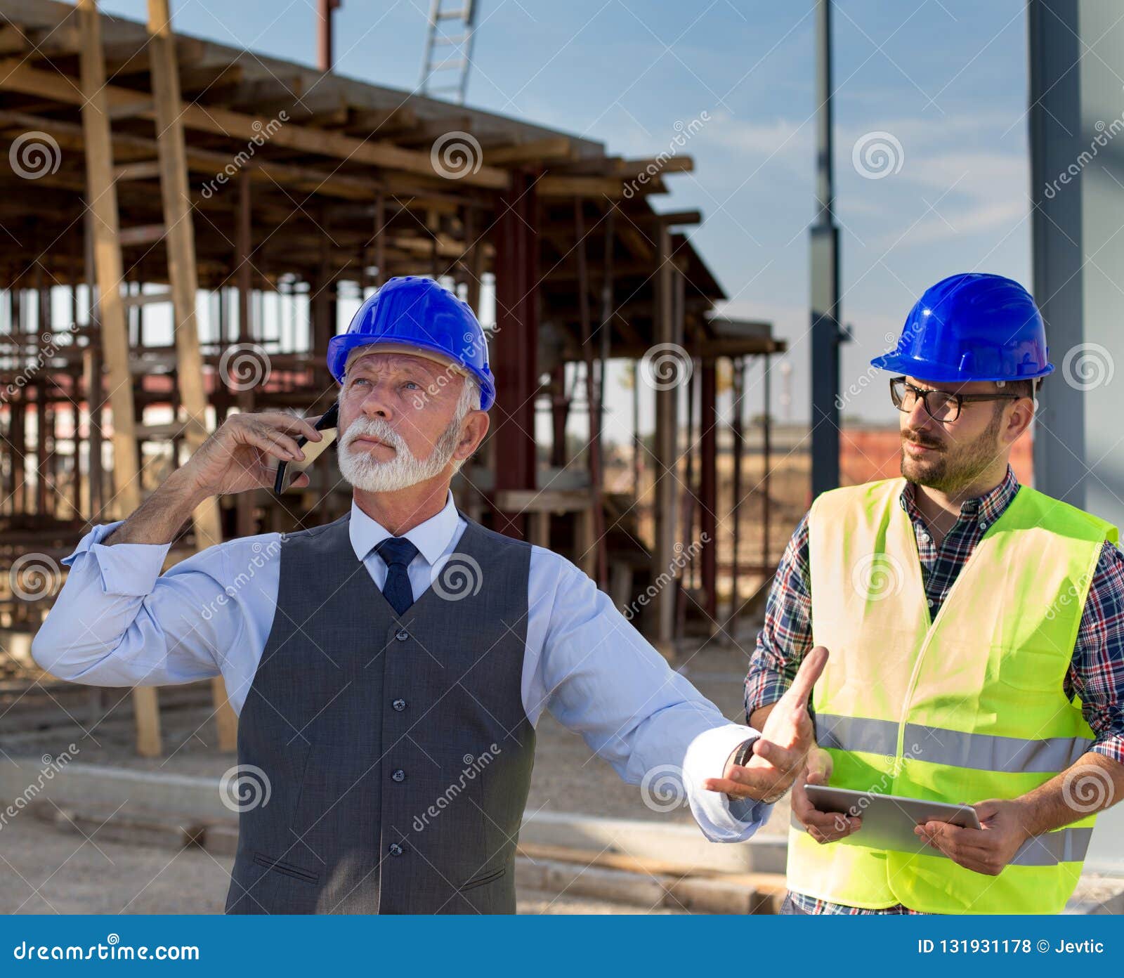 Engineer and Construction Worker at Building Site Stock Photo - Image ...