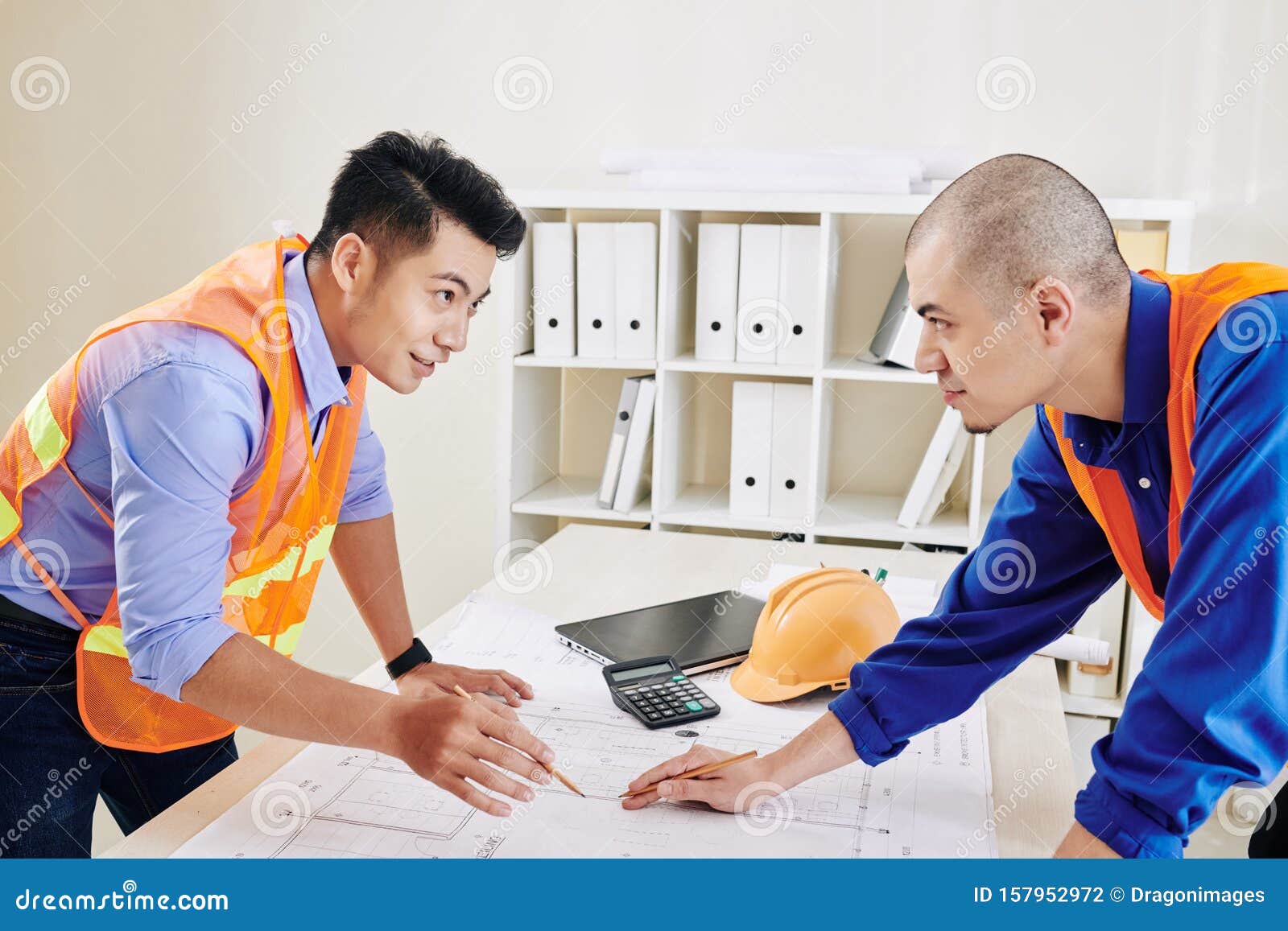 Engineer and Contractor Discussing Blueprint Stock Photo - Image of ...