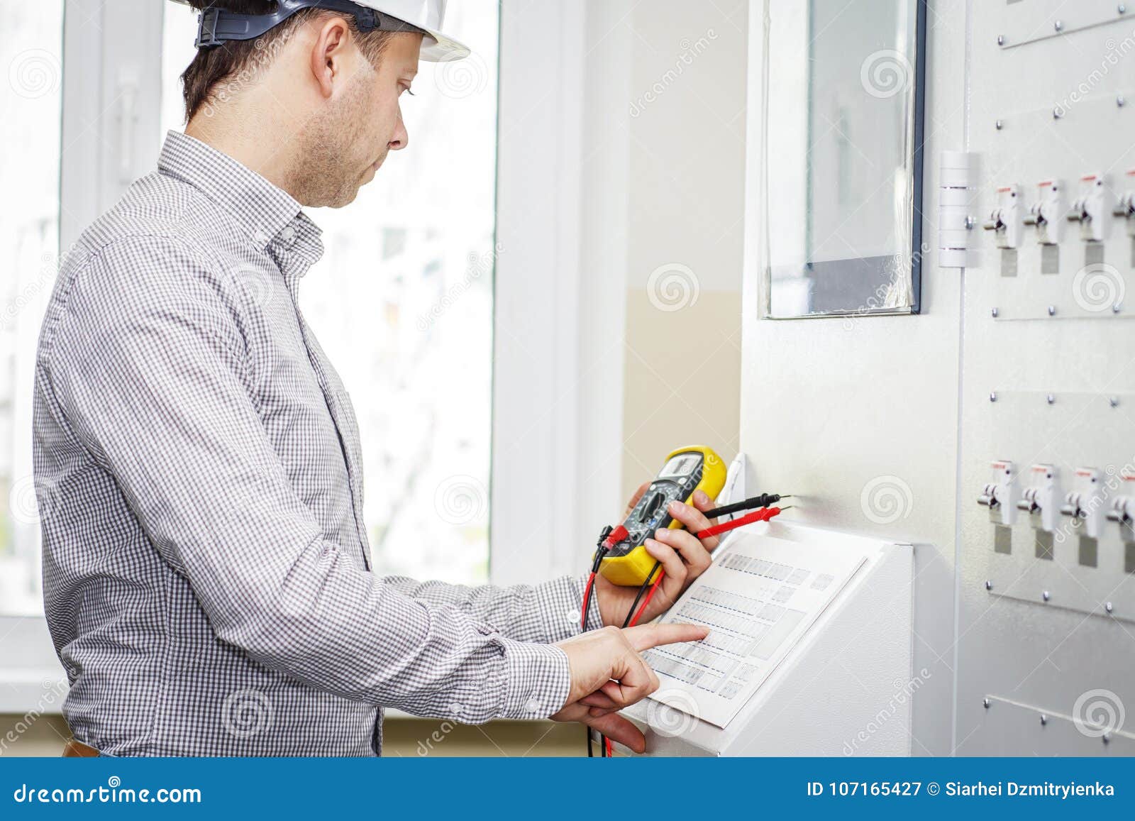 Engineer on Control Panel of Industrial Equipment. Service Engineer ...