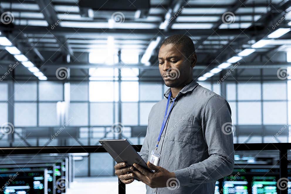 Engineer in Data Center with Tablet Automating Routine Maintenance Tasks, Stock Image - Image of ...