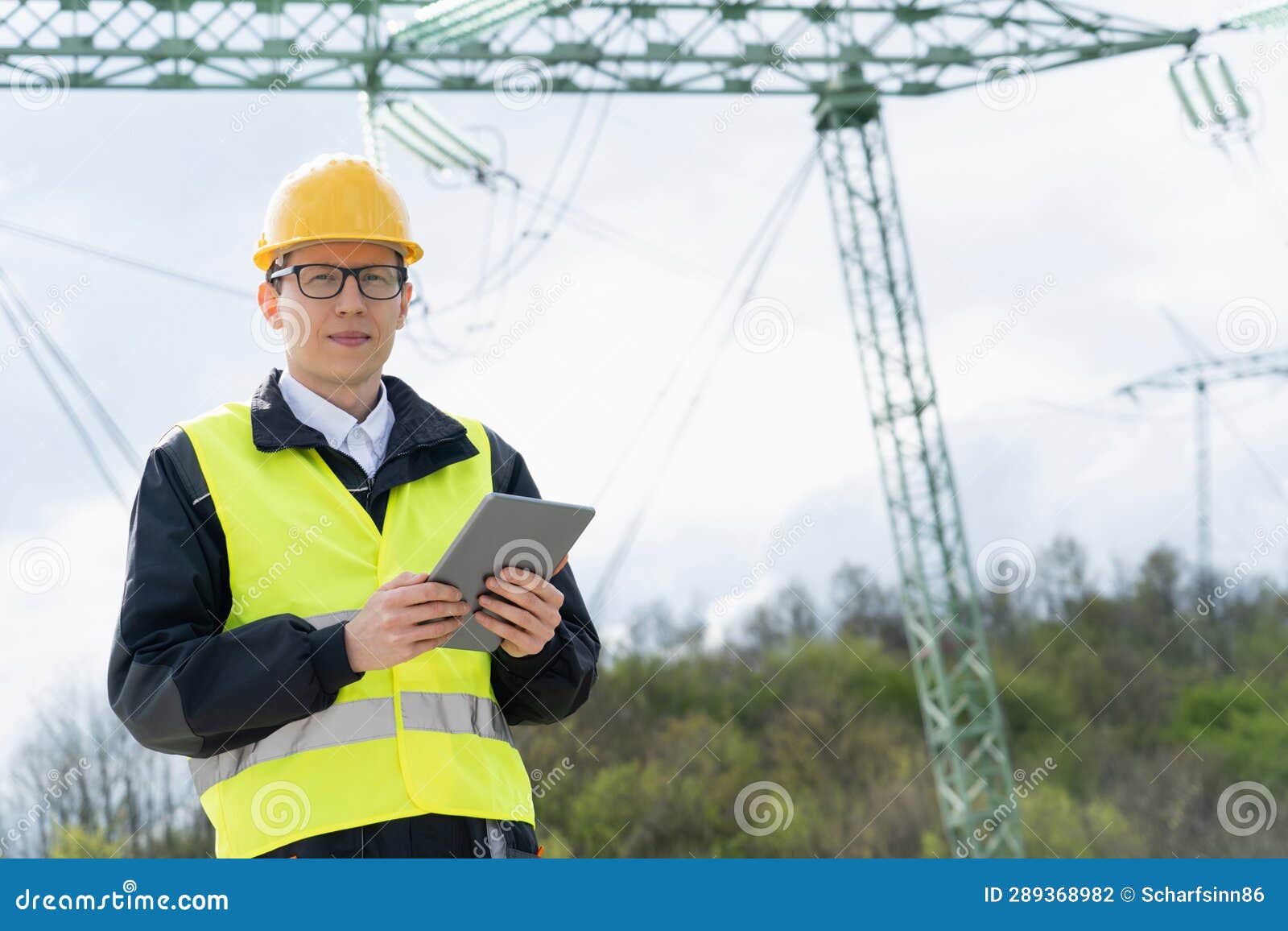 Engineer with Digital Tablet on a Background of Power Line Tower Stock ...