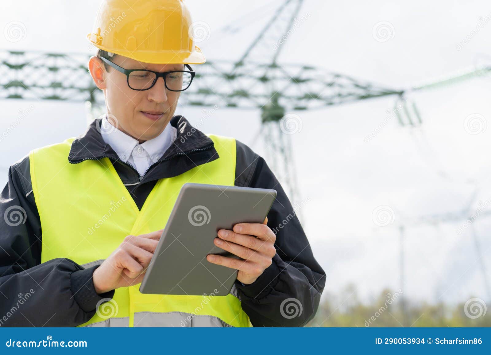 Engineer with Digital Tablet on a Background of Power Line Tower Stock ...