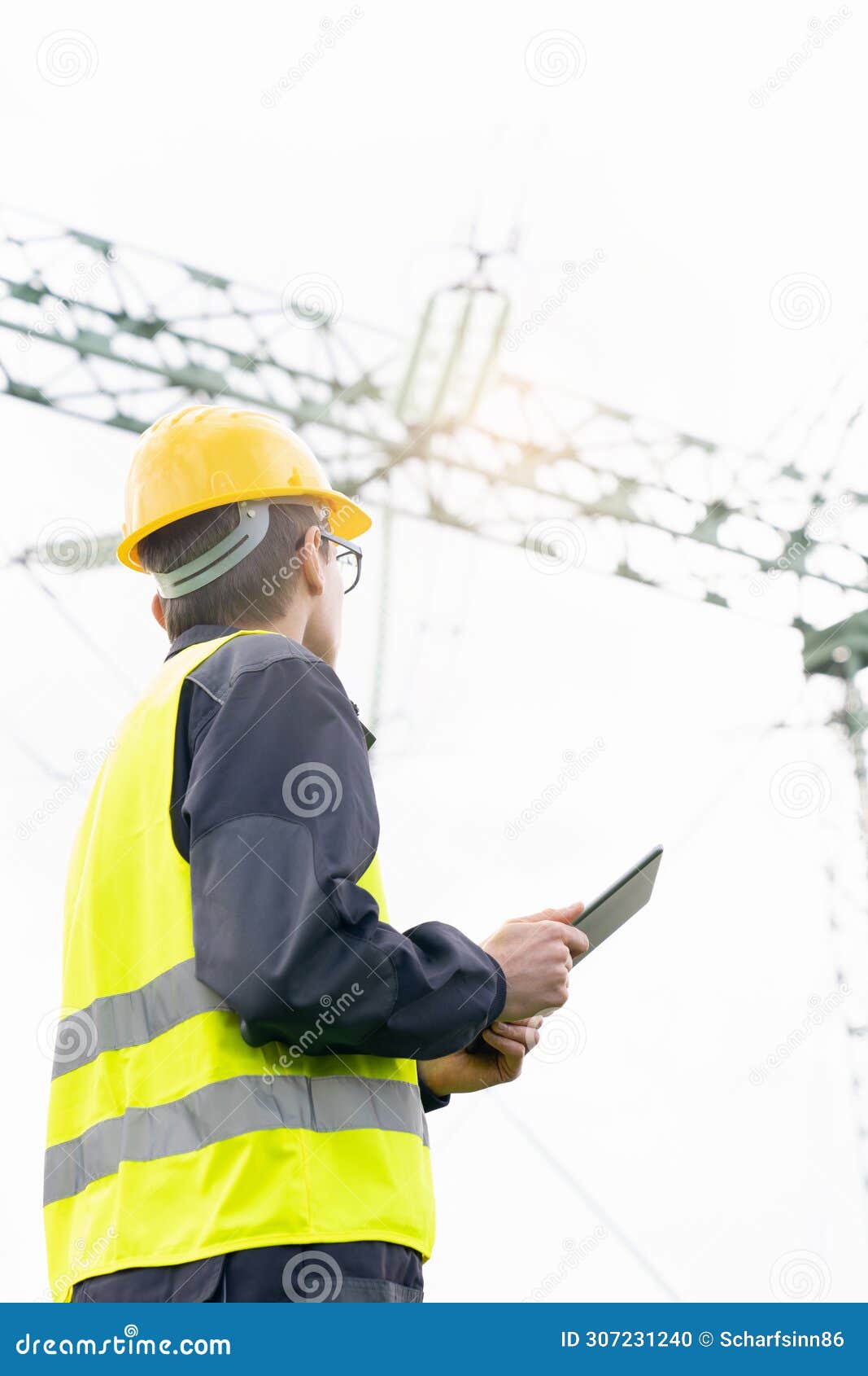 Engineer with Digital Tablet on a Background of Power Line Tower Stock ...