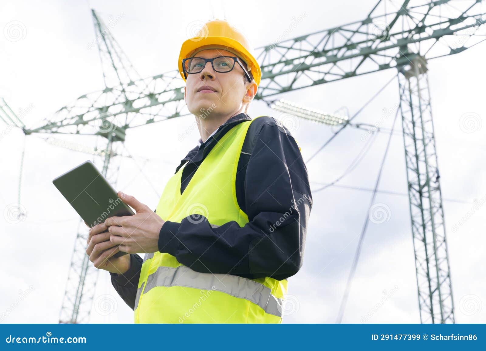 Engineer with Digital Tablet on a Background of Power Line Tower Stock ...