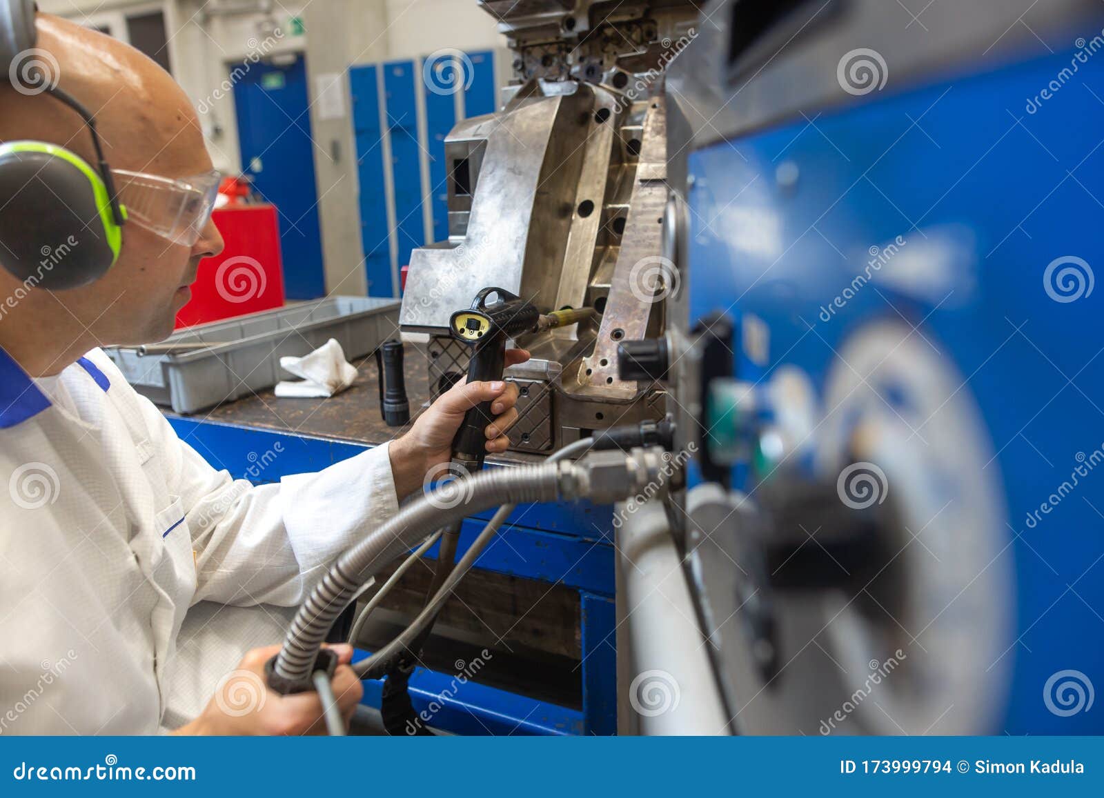 Engineer Doing Maintenance on a Injection Mold for Plastic Components ...
