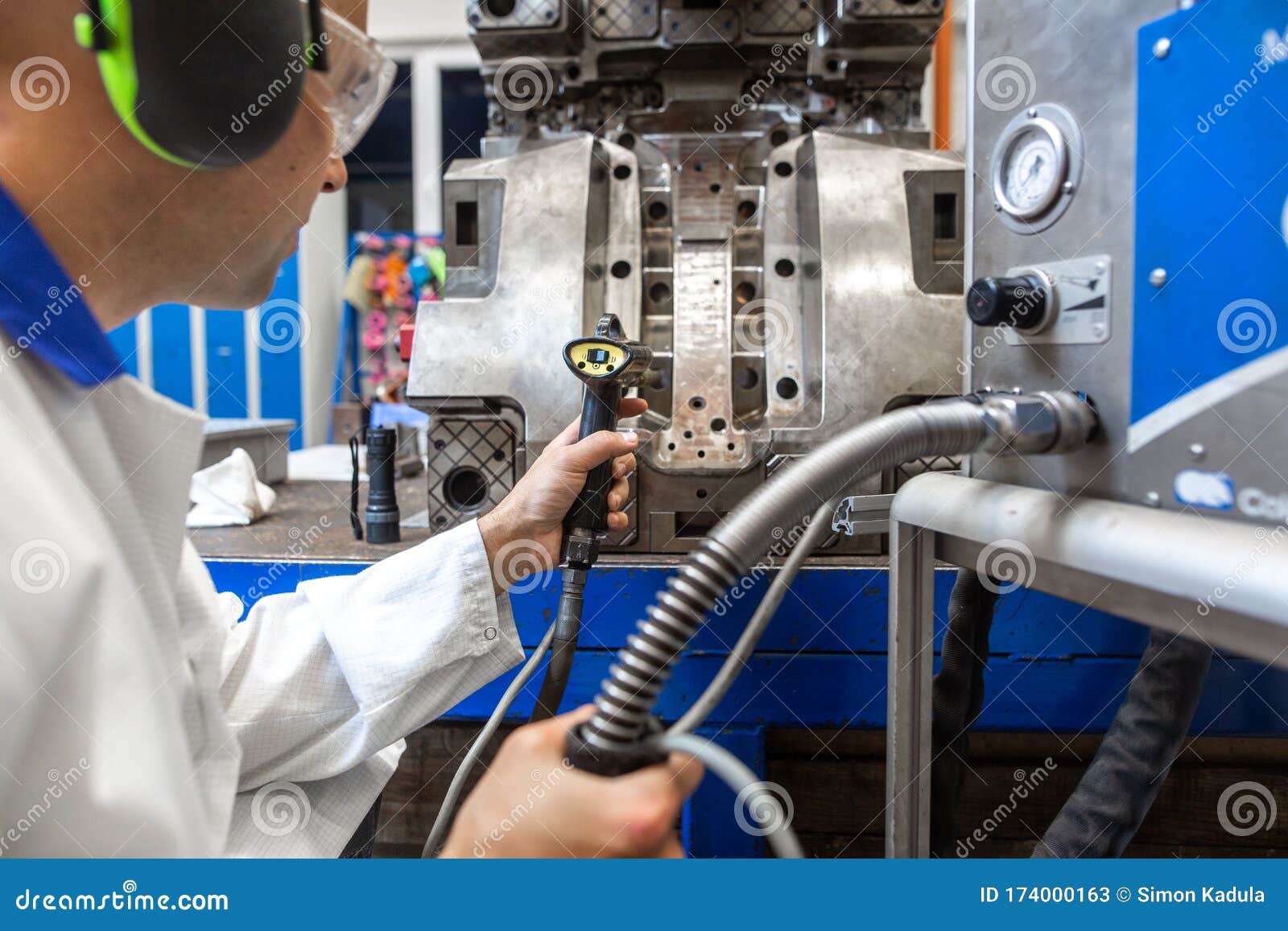 Engineer Doing Maintenance on a Injection Mold for Plastic Components ...