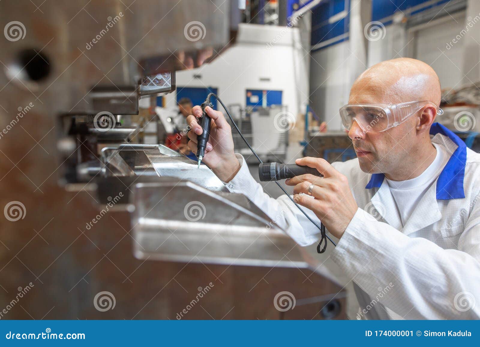 Engineer Doing Maintenance on a Injection Mold for Plastic Components ...