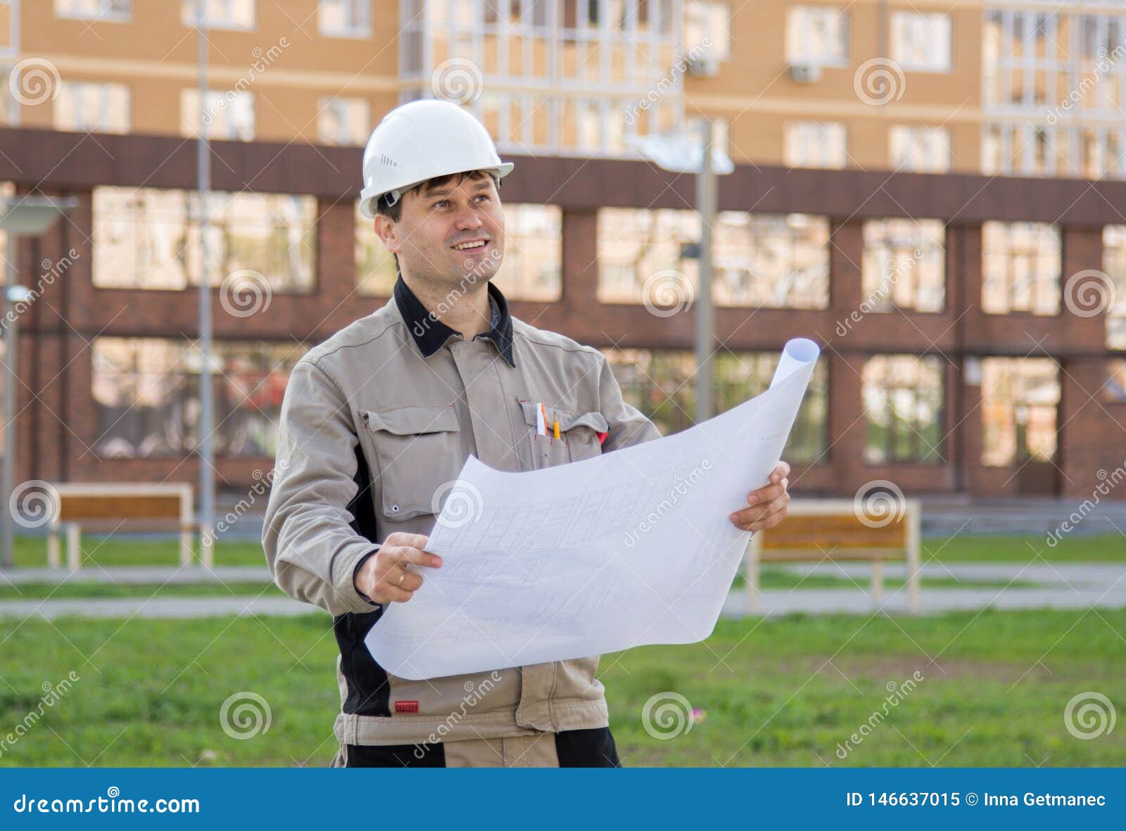 Engineer with a Drawing in His Hands, Smiling, Looking at the New ...