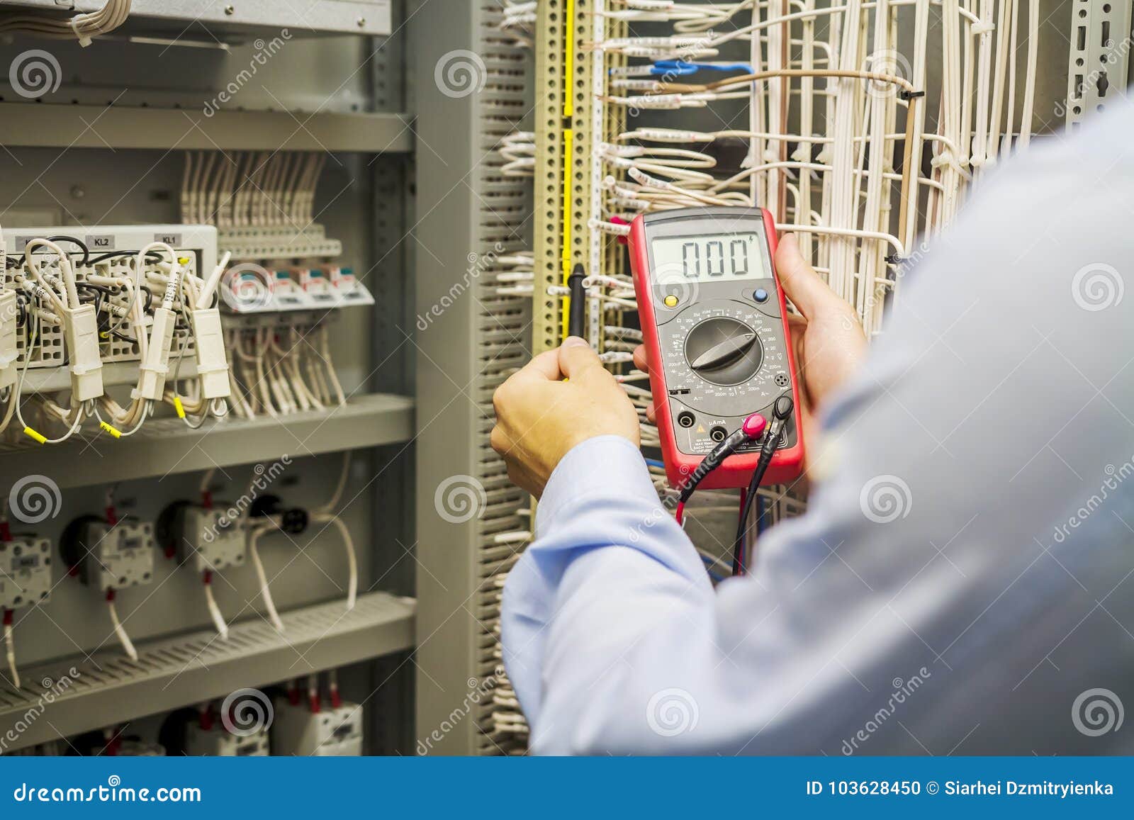 Engineer Electrician with Multimeter in Hands at Electric Automation ...