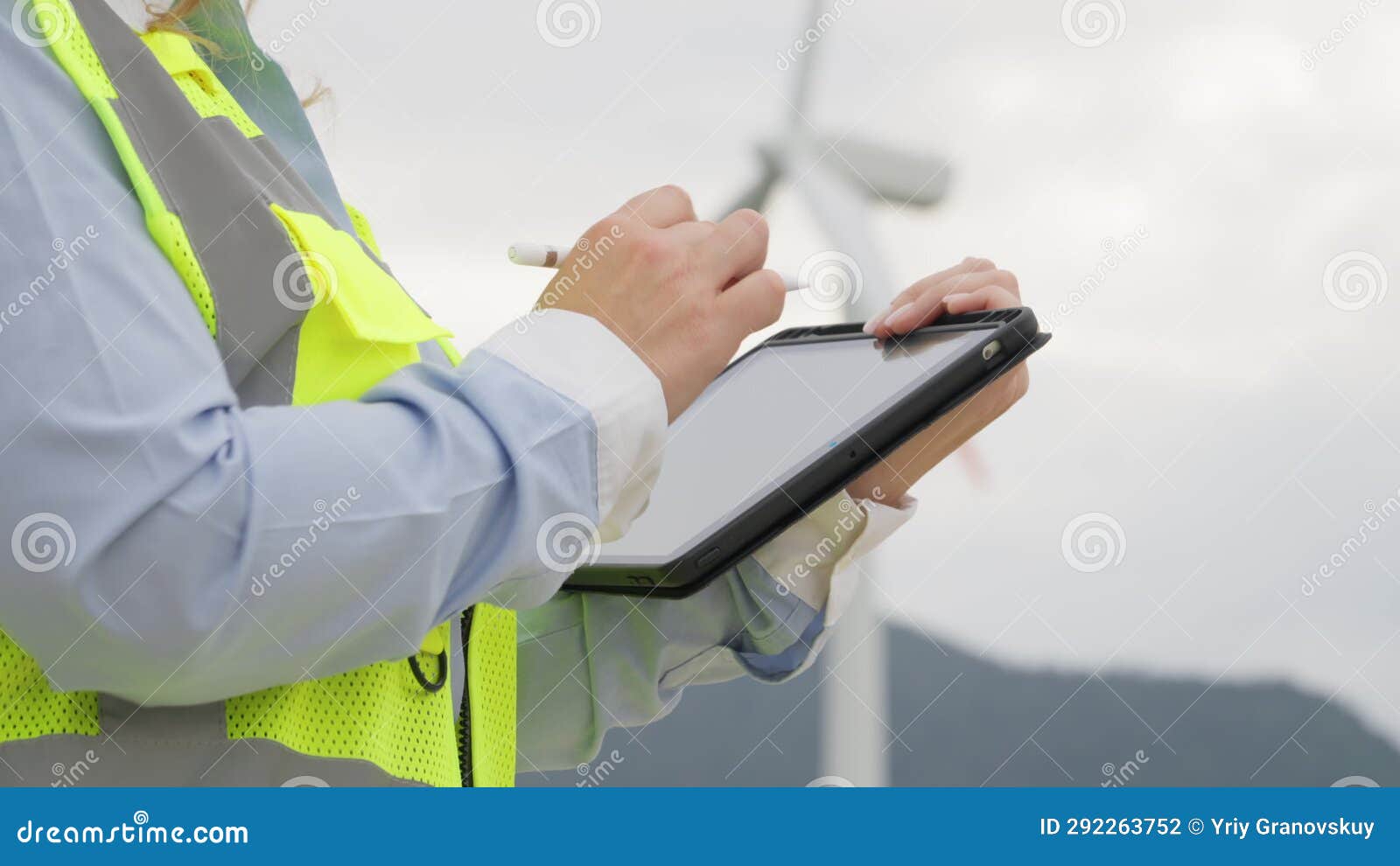 Engineer with Electronic Tablet Near Windmill: Technical Consideration ...