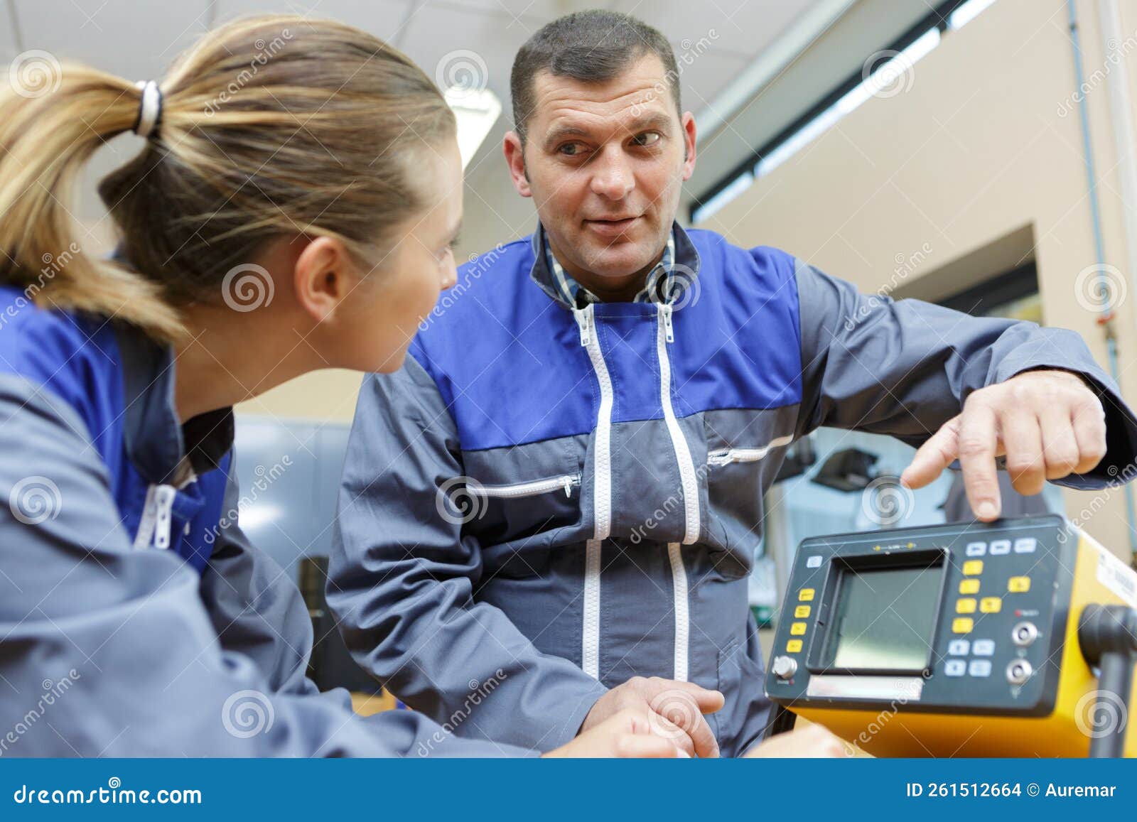 Engineer Explaining Electronic Box To Female Apprentice Stock Photo ...