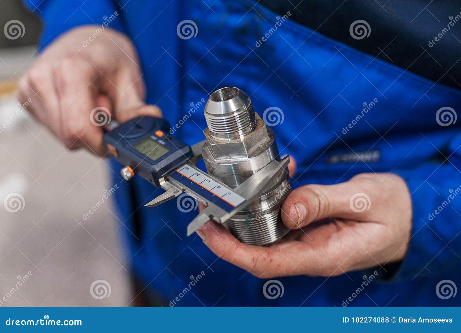 Close-up of the Hand of a Worker Measuring a Part from the Mechanism of ...
