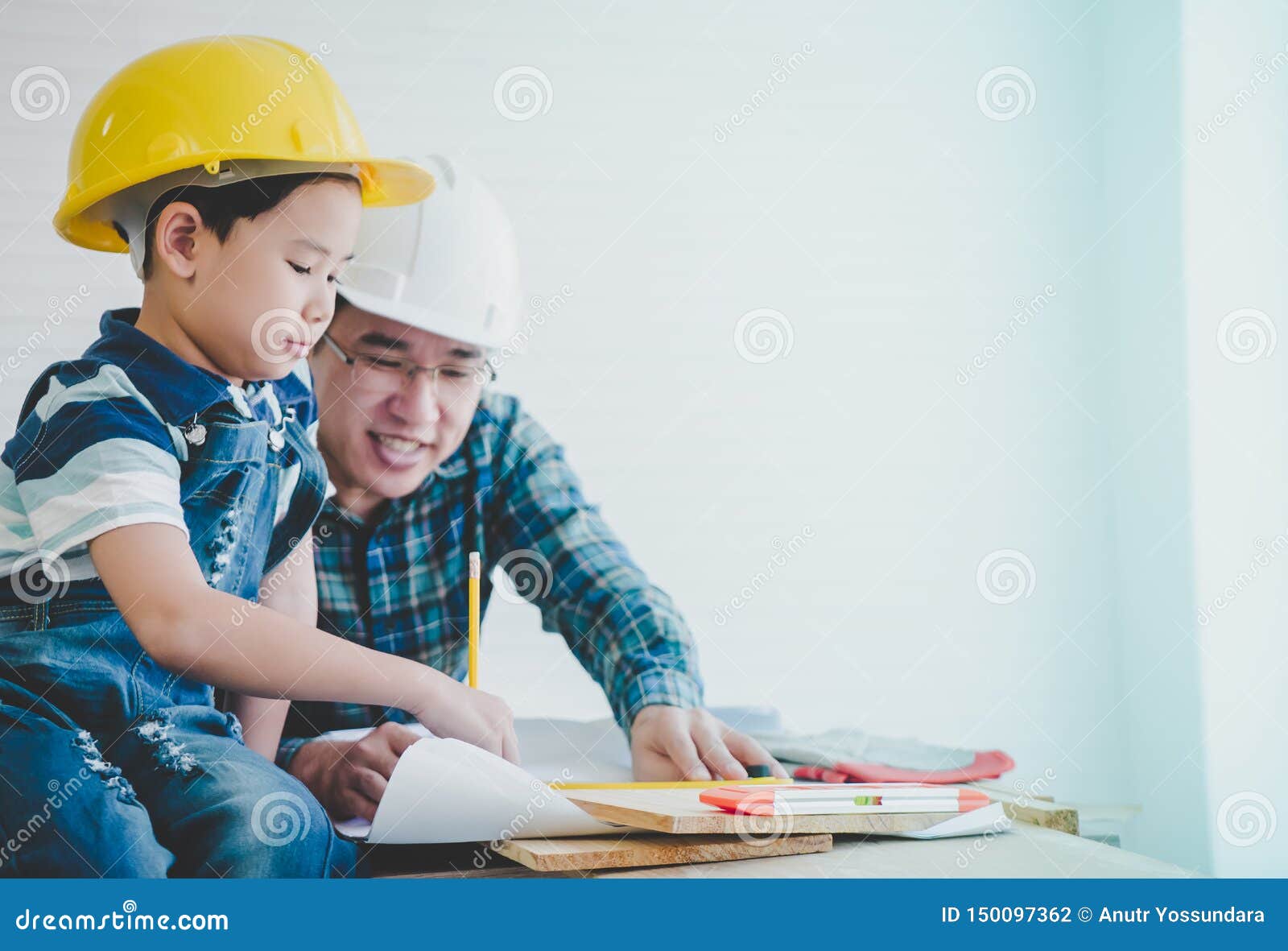 Engineer Father Teaching His Son To Read the Construction Plan Paper ...