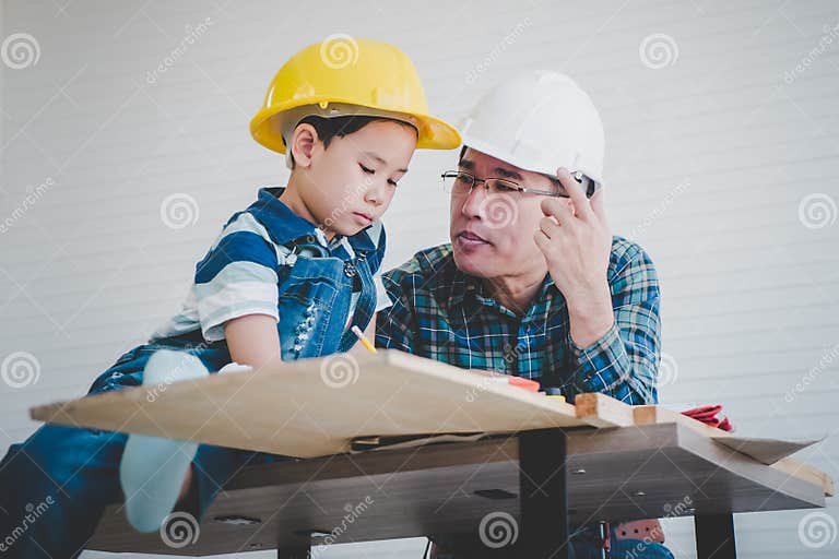 Engineer Father Teaching His Son To Read the Construction Plan Paper ...