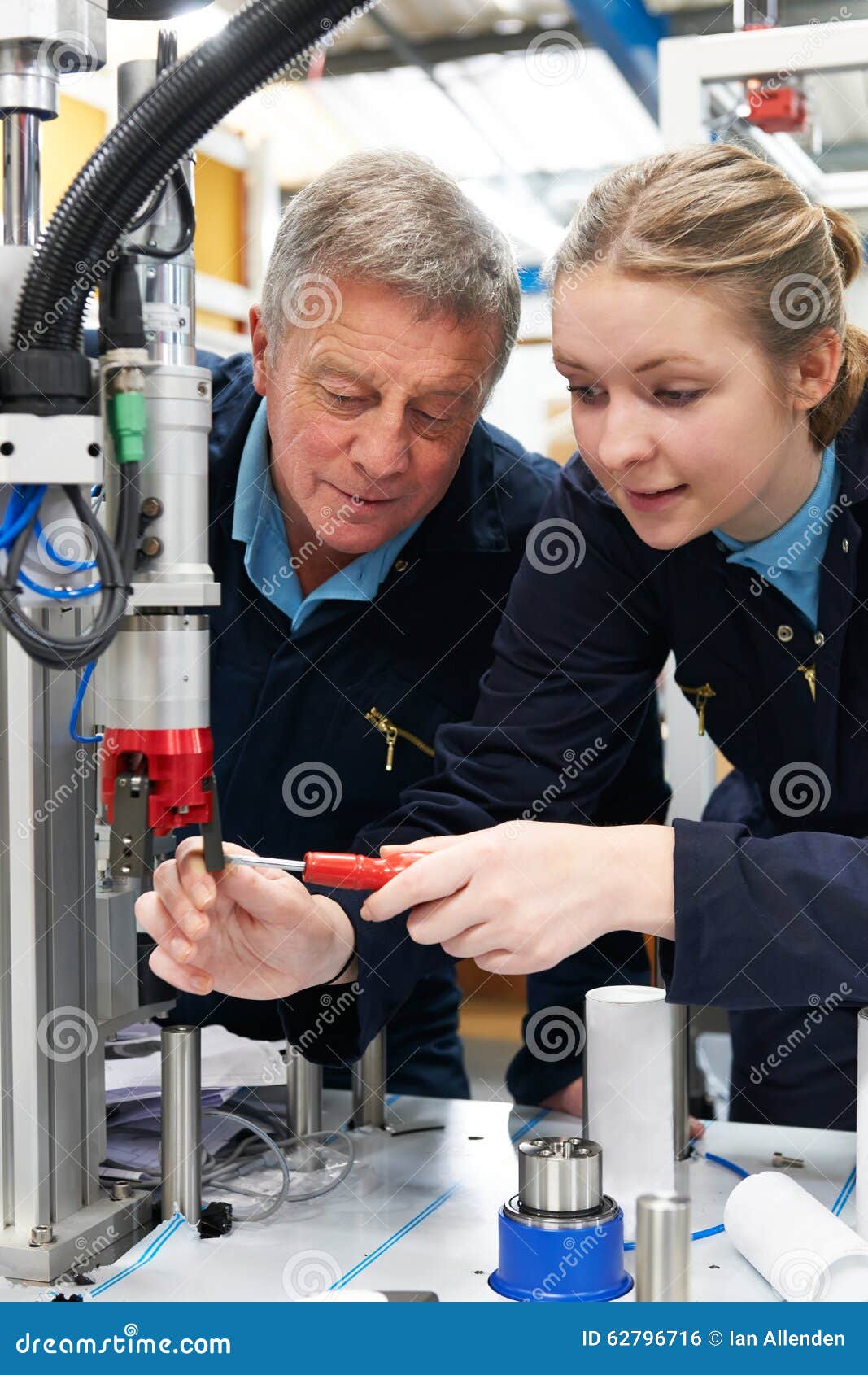 Engineer and Female Apprentice Working on Machinery in Factory Stock ...