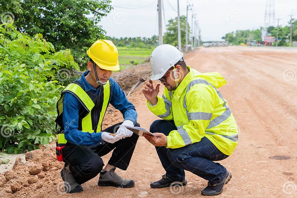 Engineer and Foreman Analyzing Road Construction Soil before Pouring ...