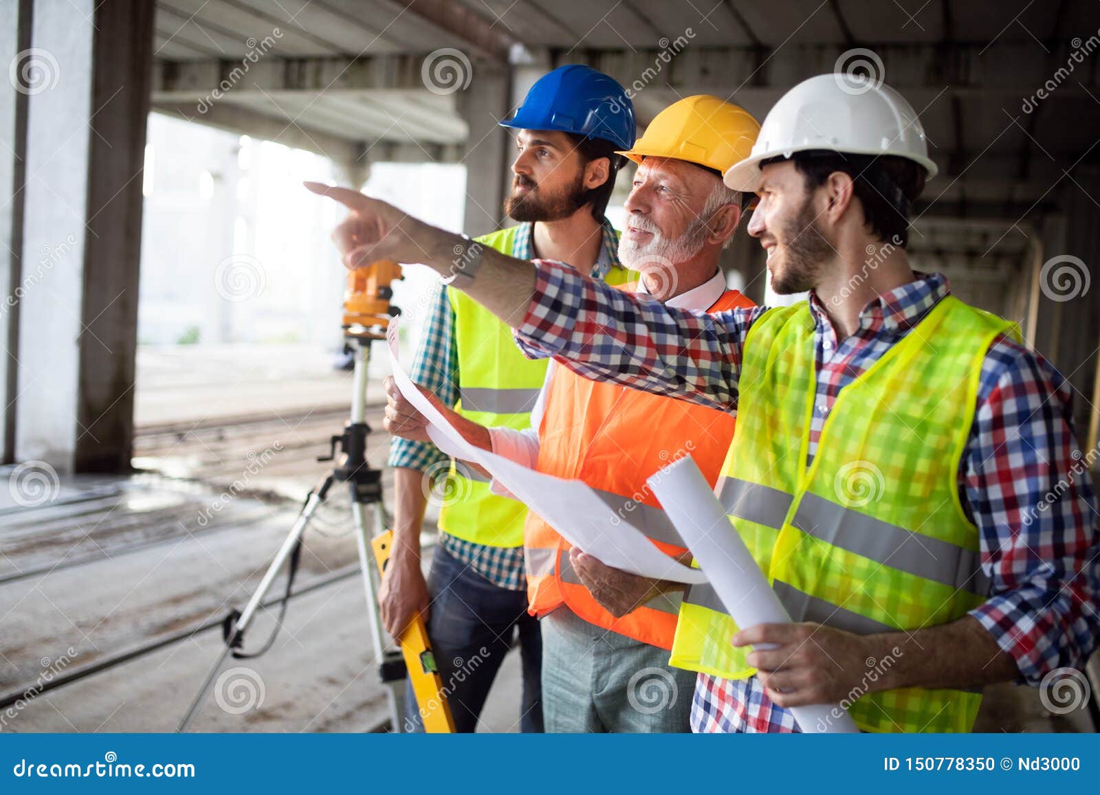 Engineer, Foreman and Worker Discussing in Building Construction Site ...