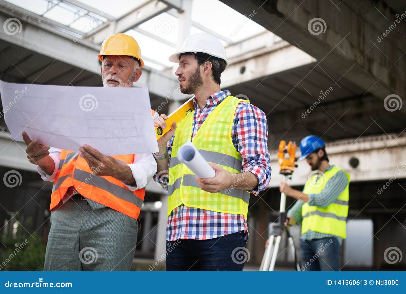 Engineer, Foreman and Worker Discussing in Building Construction Site ...