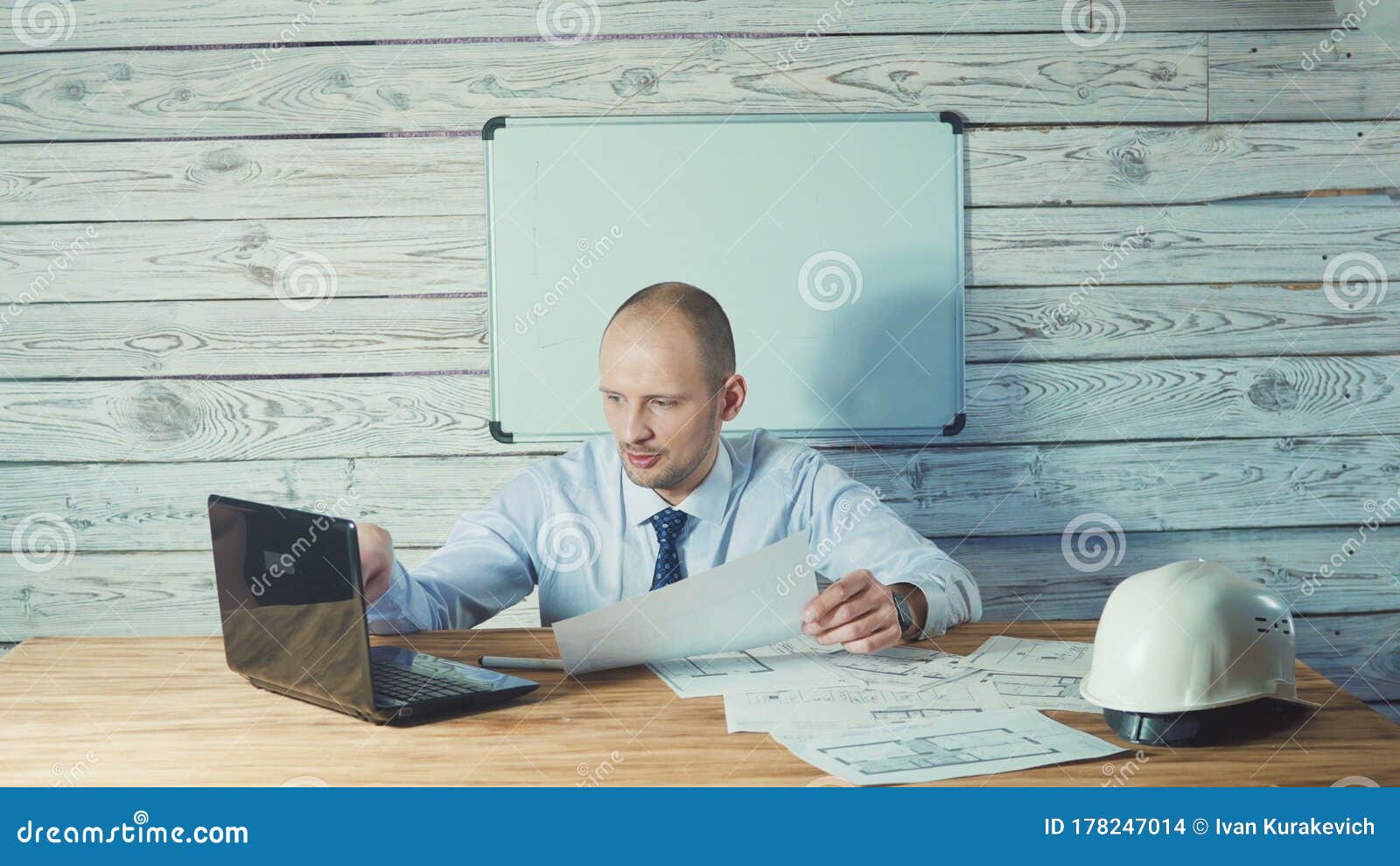 Engineer or Foreman Working with Project Documentation in the Office ...