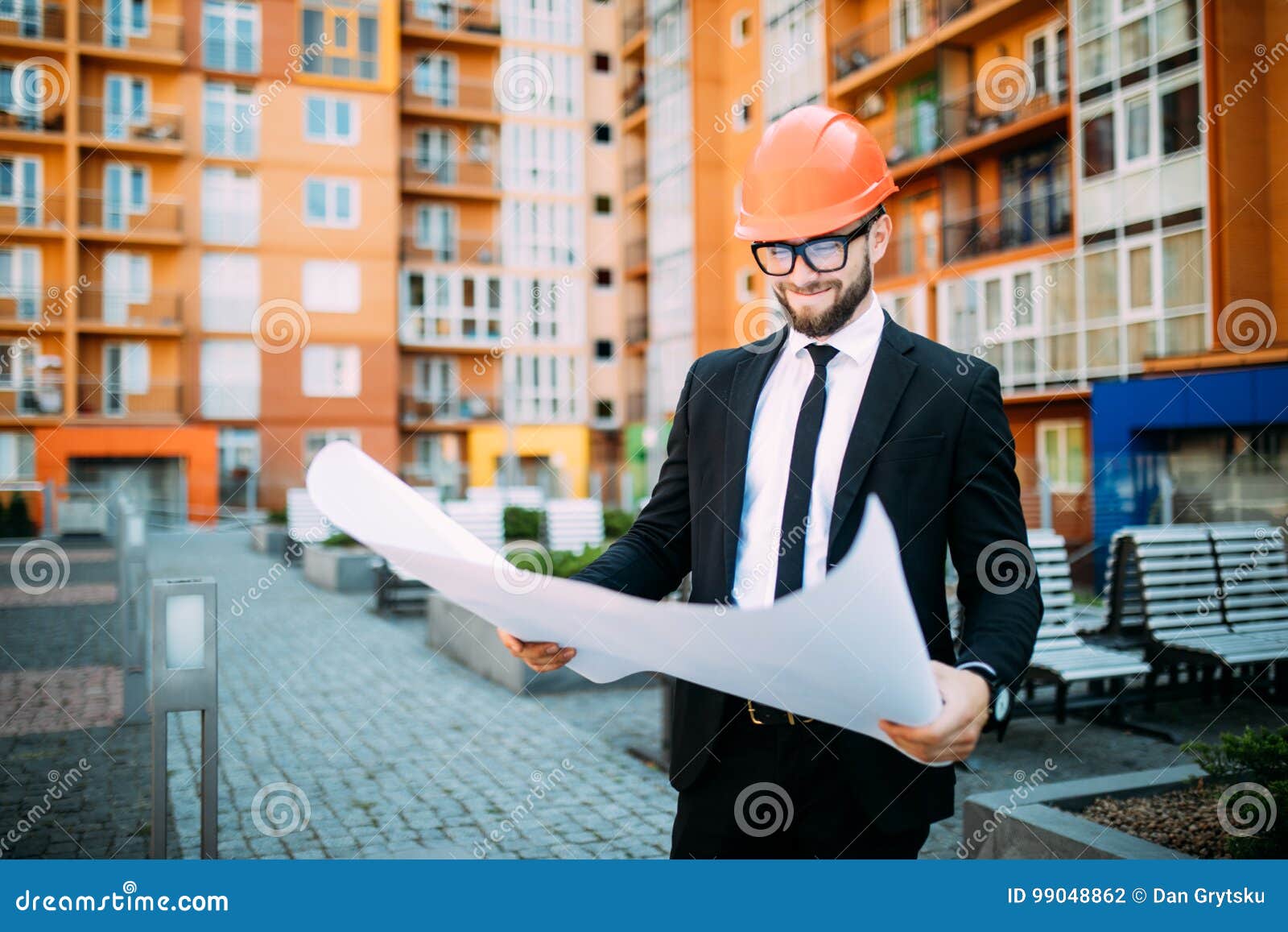 Engineer in Front of Modern Building with Plan Looking at Blueprint ...