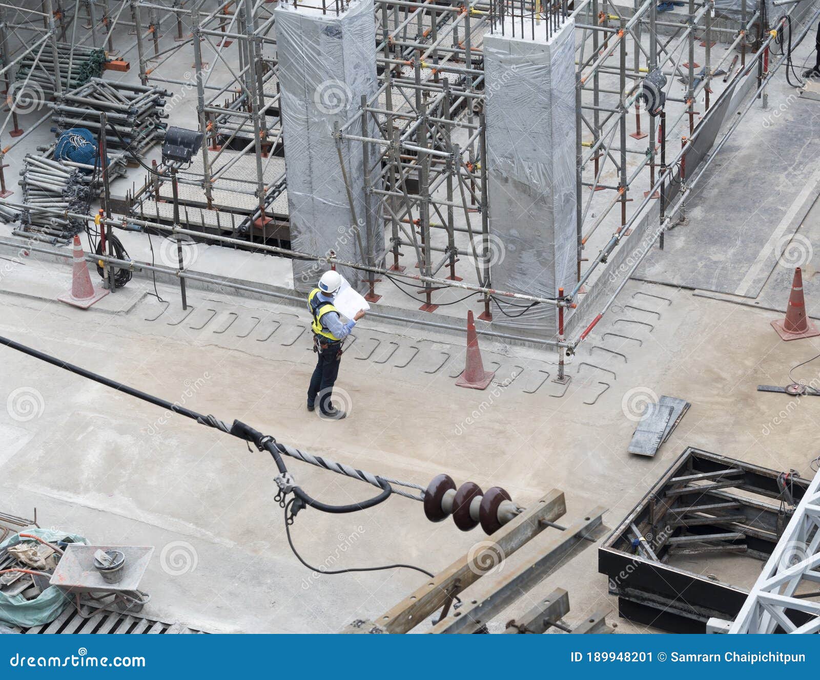 Engineer with Full Safety Set in Construction Area Checking Drawing ...