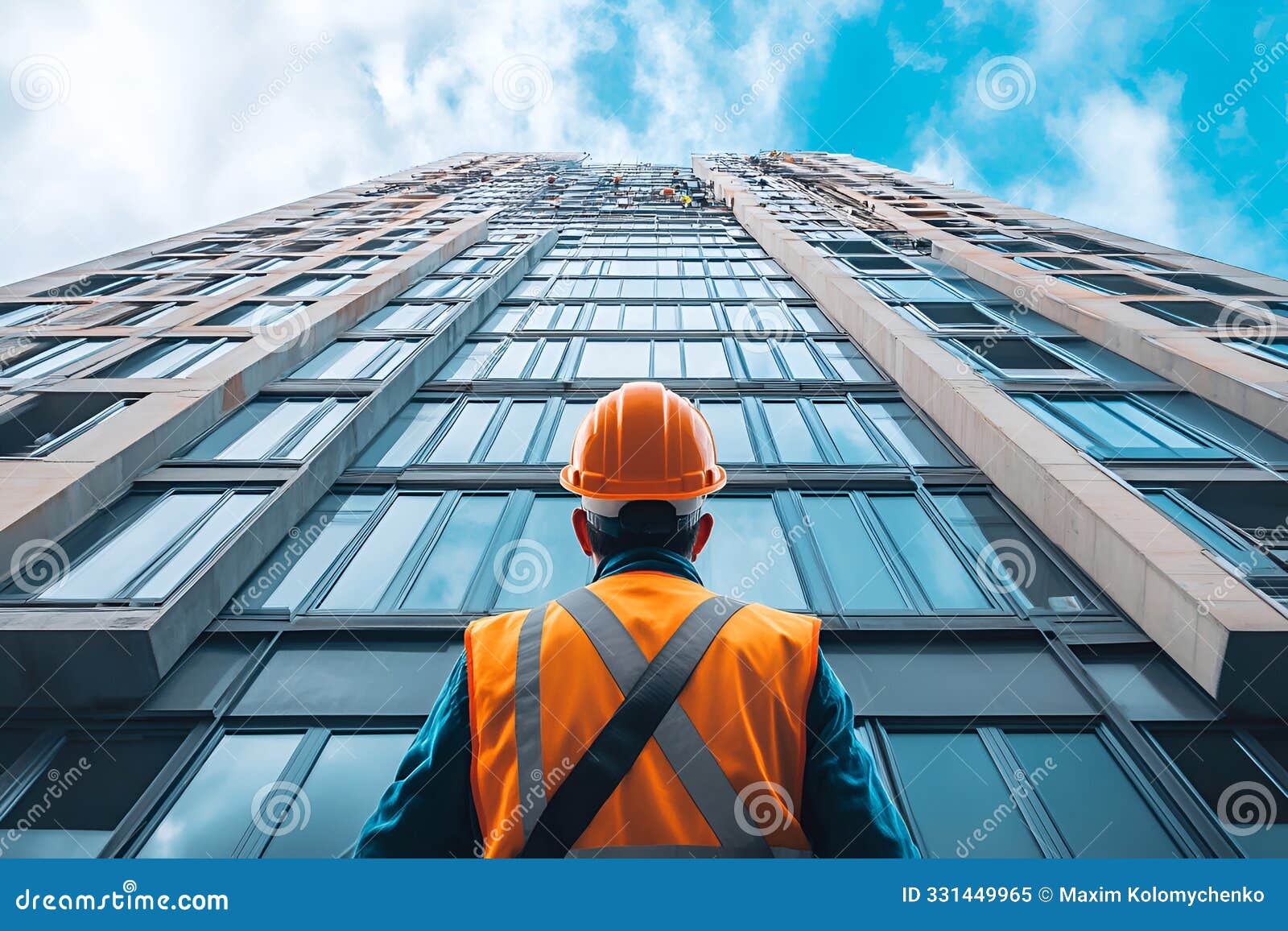 An Engineer in a Hard Hat Inspects the Facade of a High-rise Building ...
