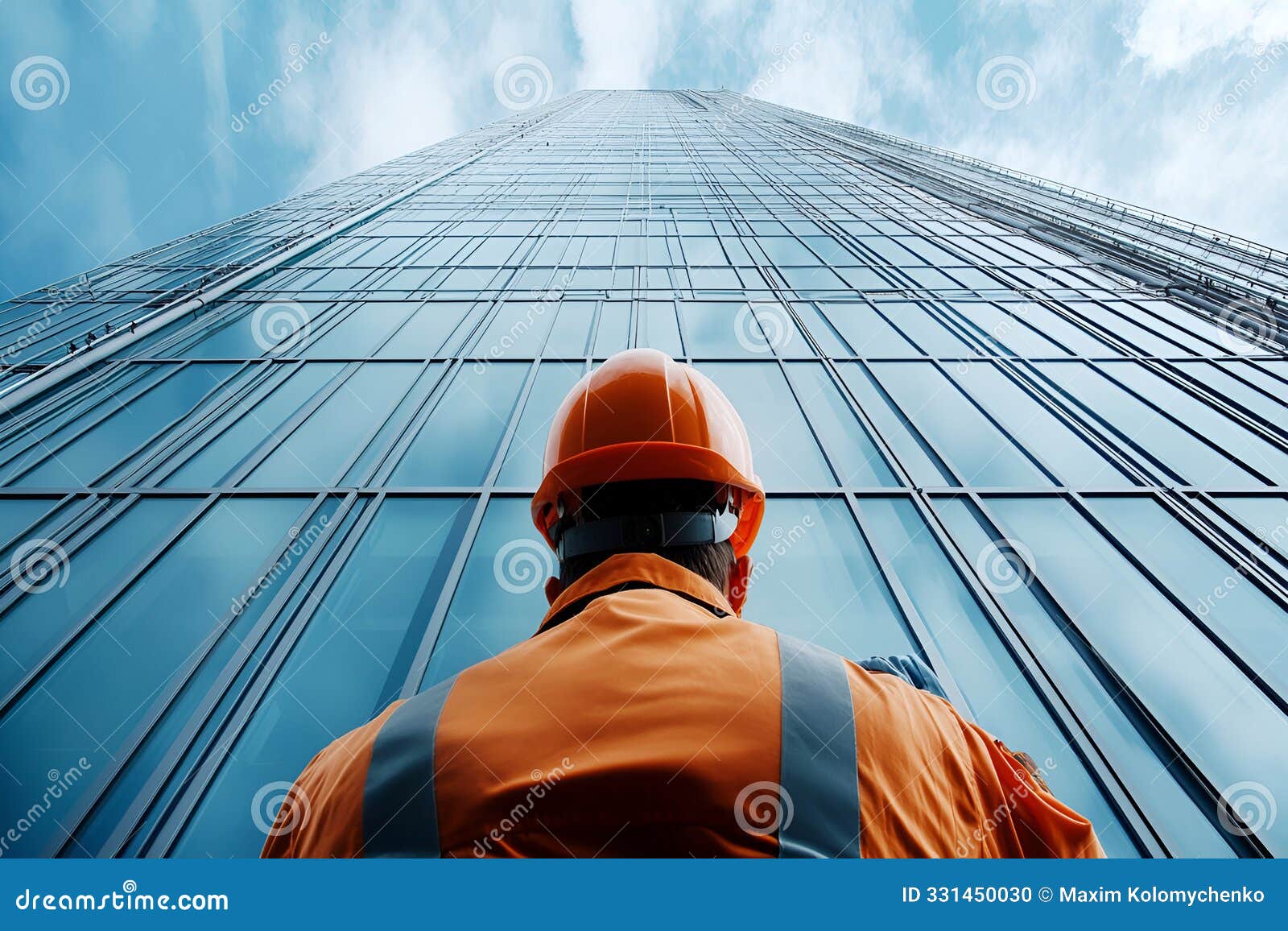 An Engineer in a Hard Hat Inspects the Facade of a High-rise Building ...