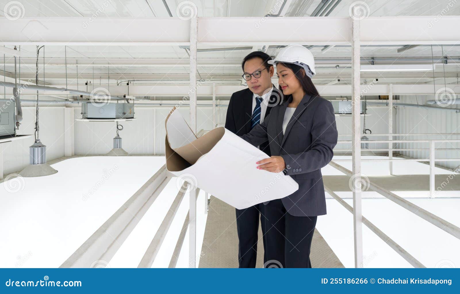 Engineer in Hardhat Hold the Ventilation System Construction Plan while ...