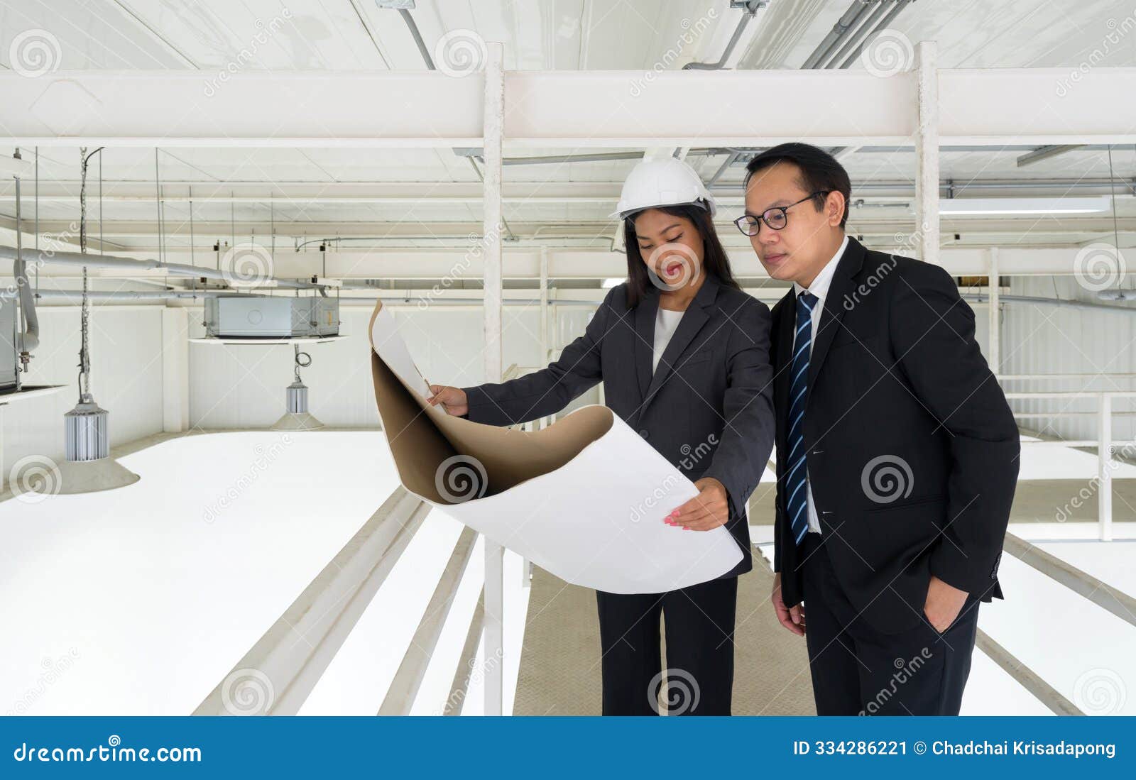 Engineer in Hardhat Hold the Ventilation System Construction Plan while ...