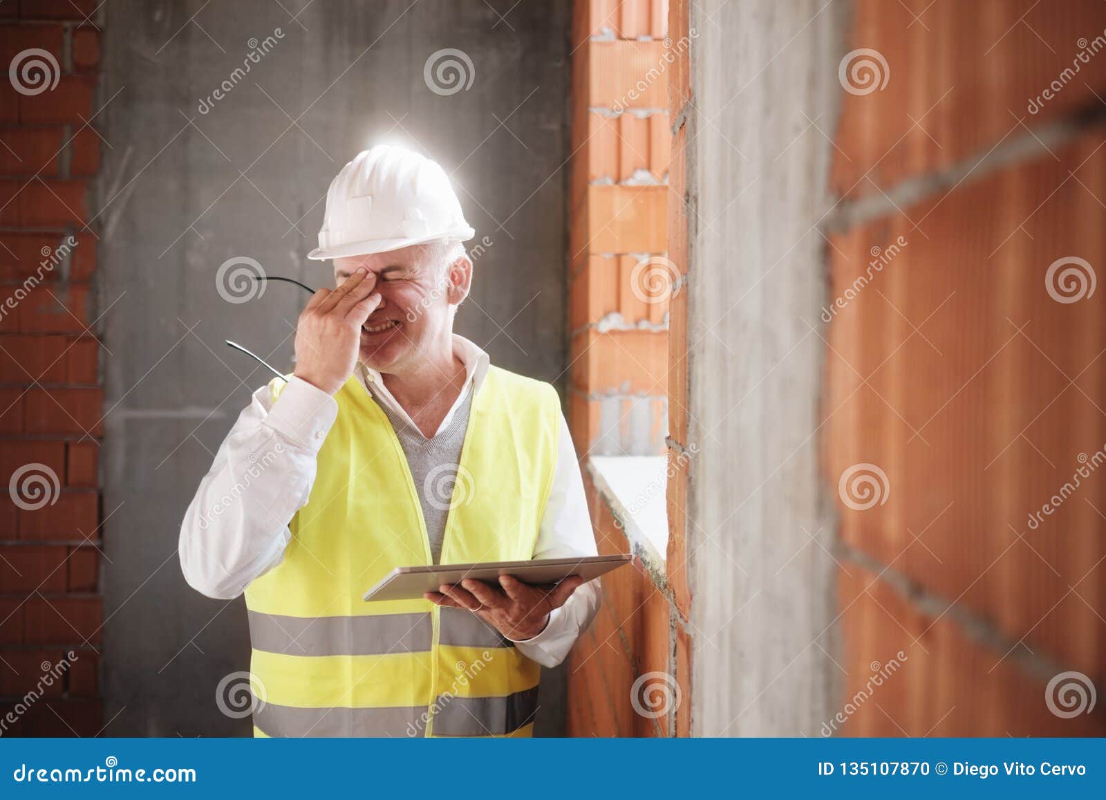Engineer with Headache at Work with Computer in Construction Site Stock ...
