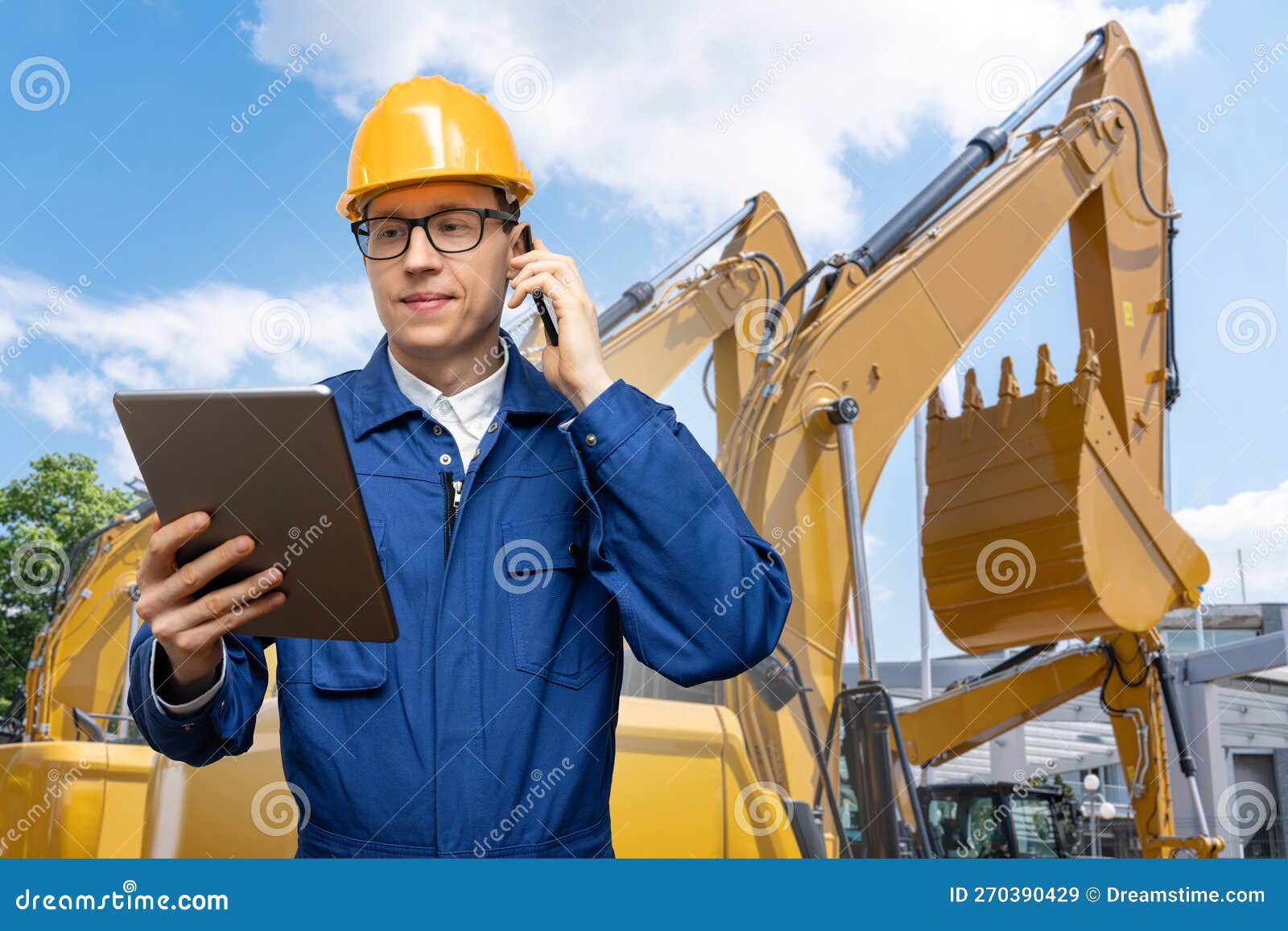 Engineer in a Helmet with a Digital Tablet and Phone Stock Image ...