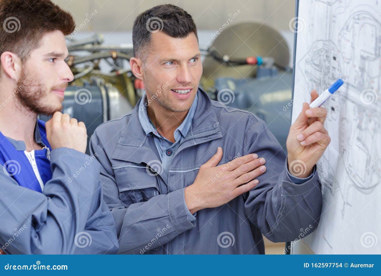 Engineer and Apprentice Looking at Detailed Drawings Stock Photo ...