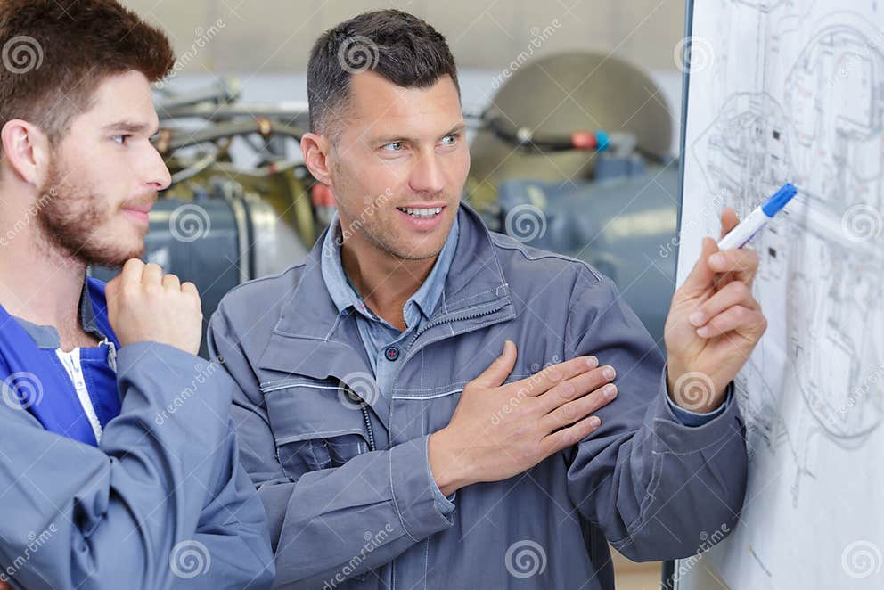 Engineer and Apprentice Looking at Detailed Drawings Stock Photo ...